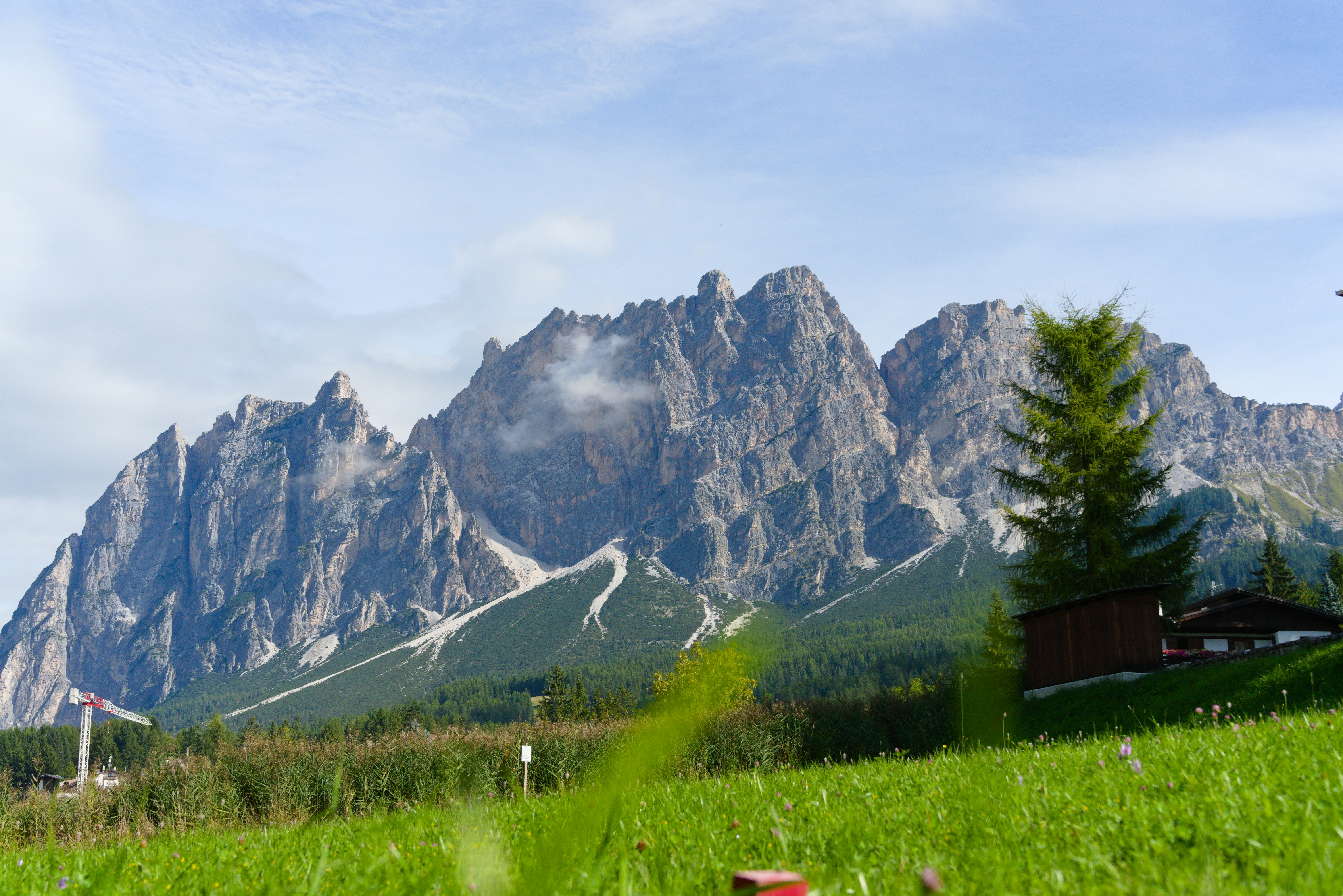 Sunlit Alpine Peak Rising Beyond a Lush Meadow