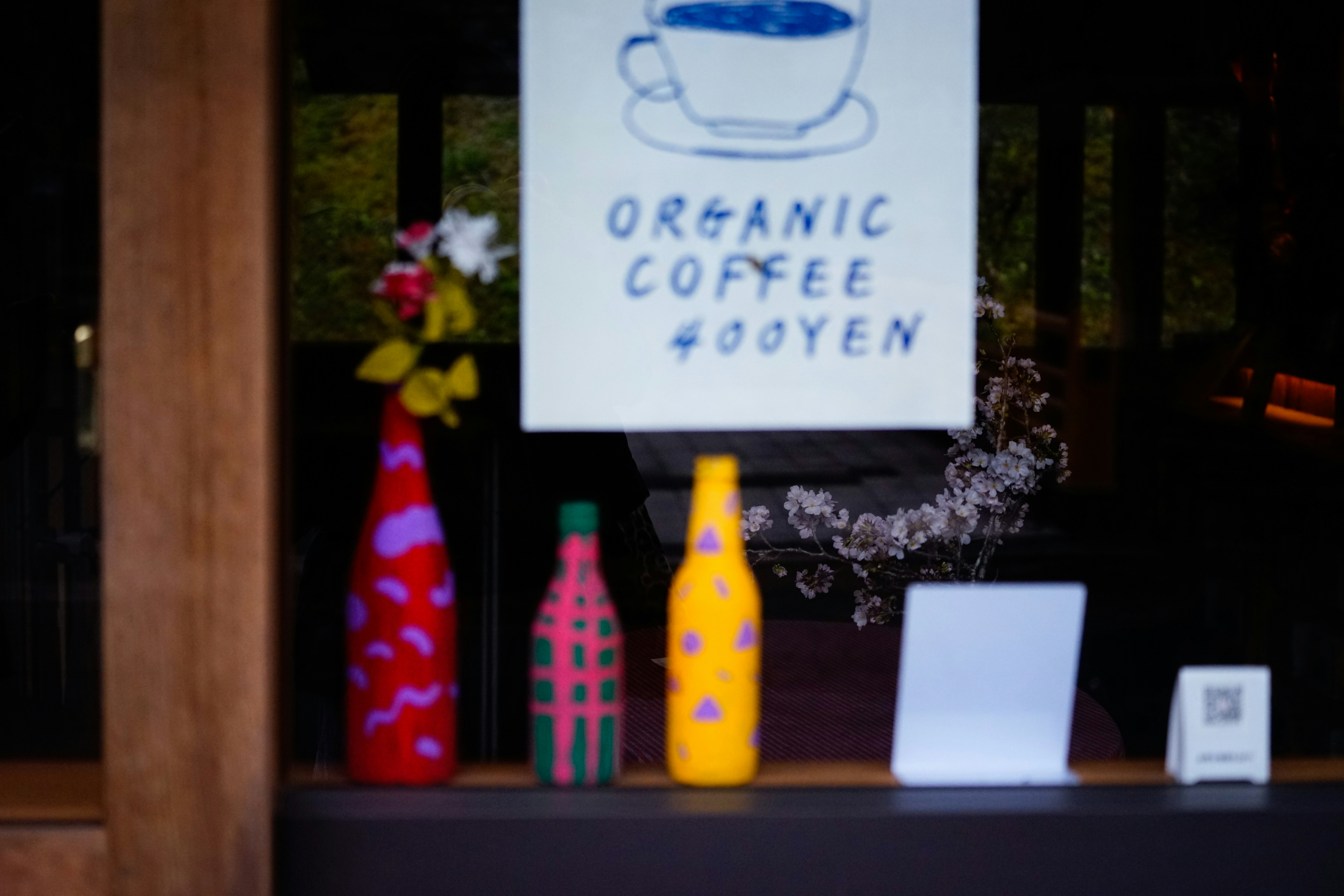 Organic Coffee Sign Framed by Colorful Bottles