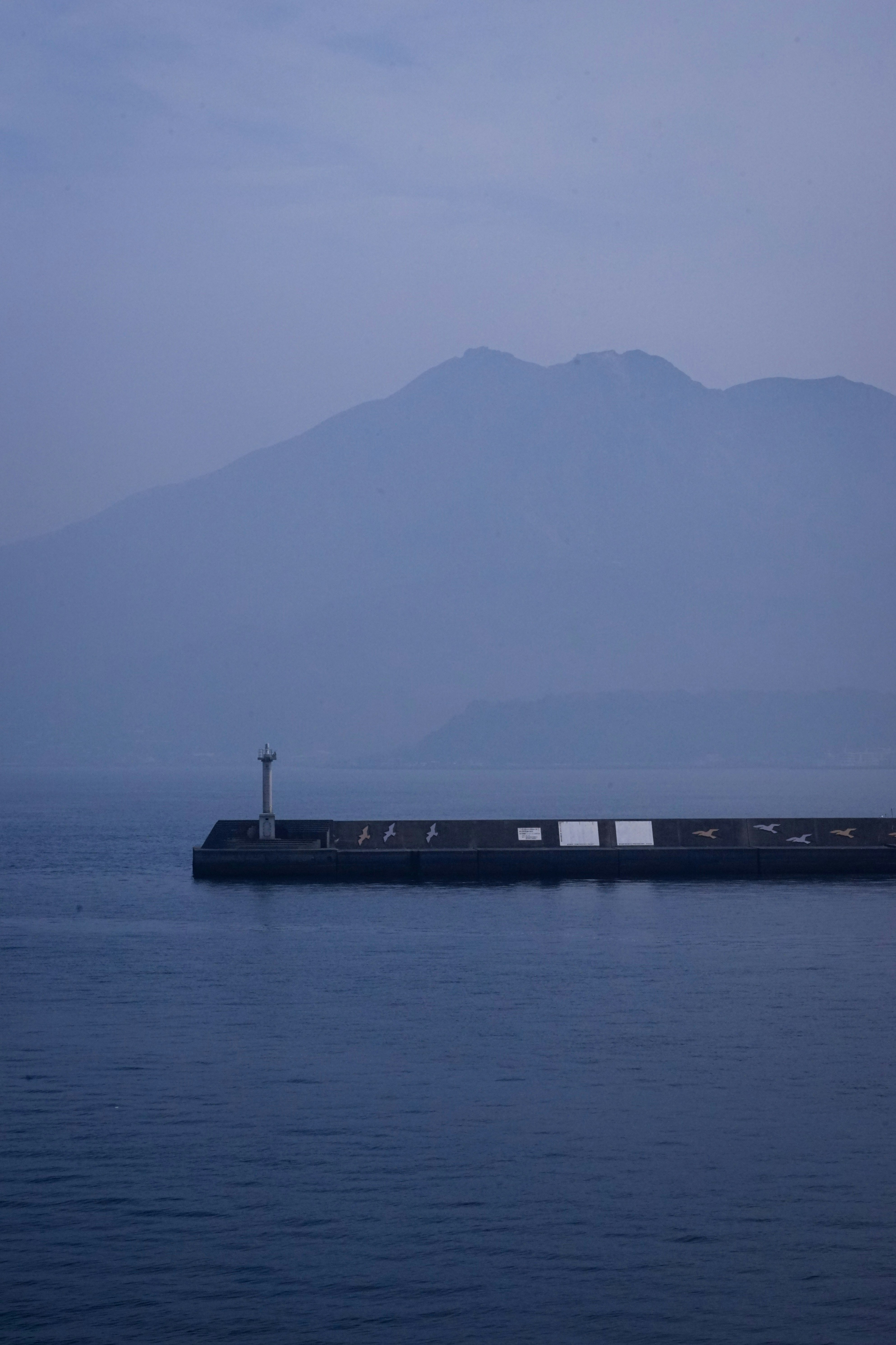 Misty Breakwater at Distant Summit
