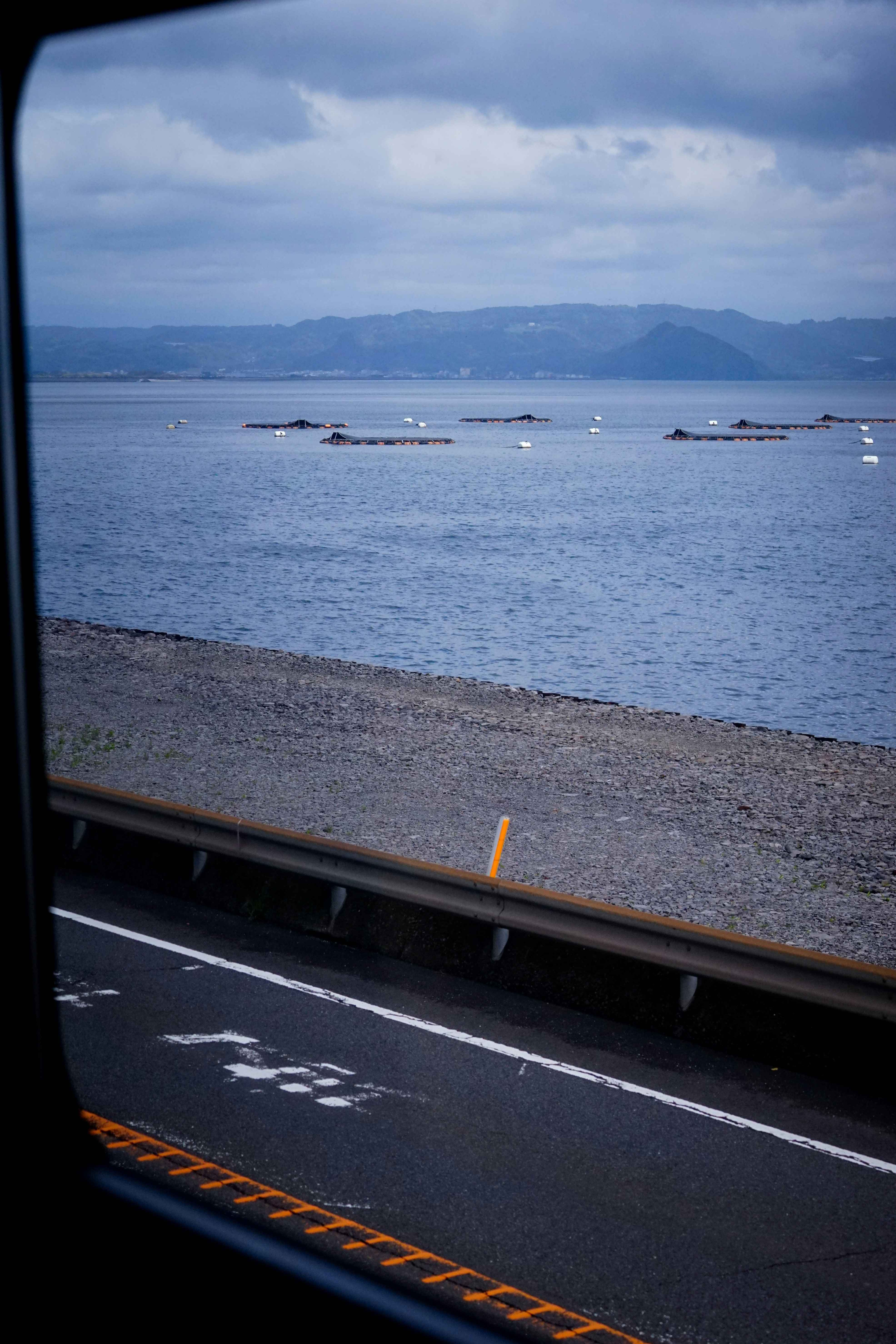 Sea Highway Window: Light, Rail, and Distant Isles
