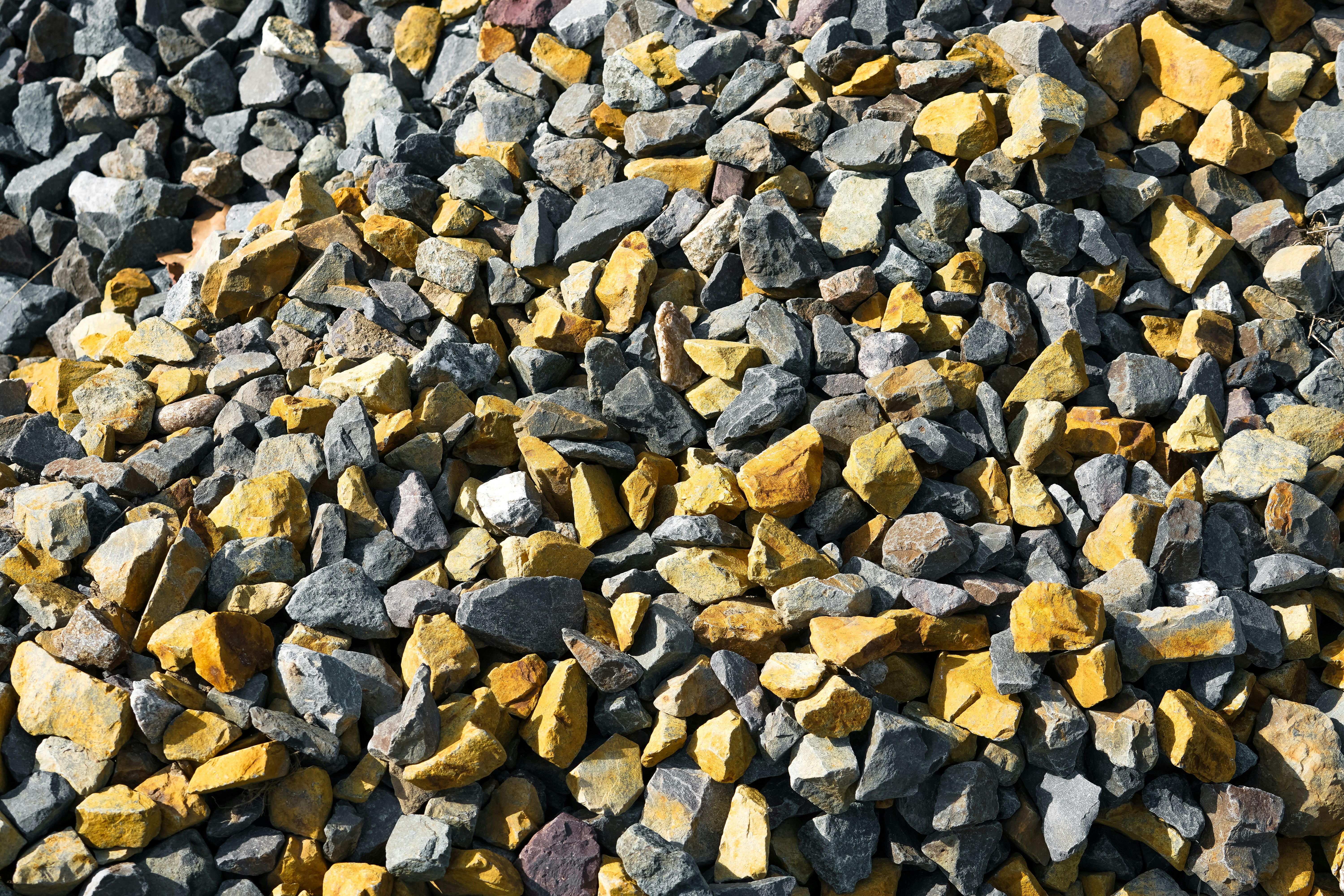 Amber and slate gravel blanket under noon sun