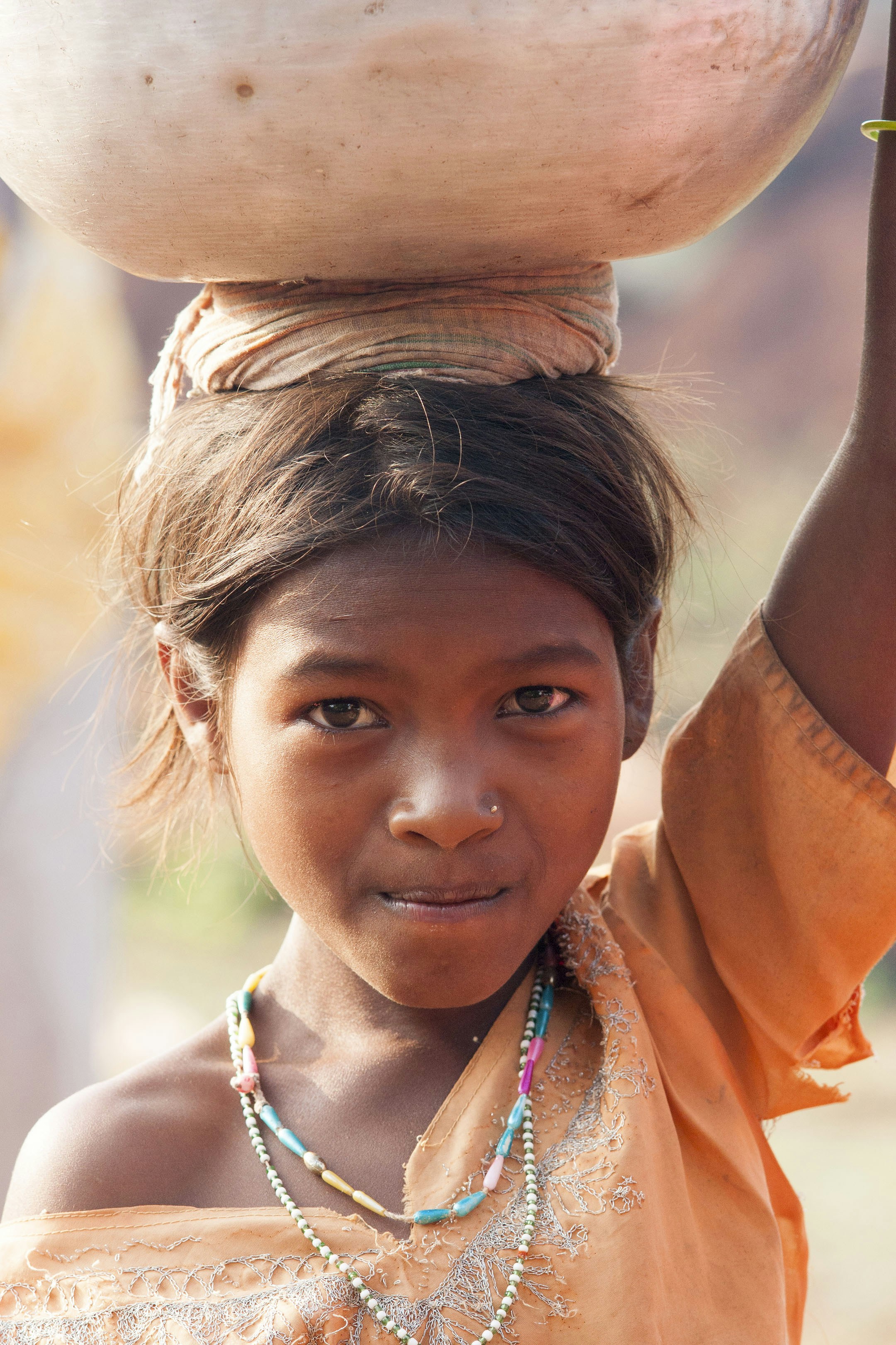 Balancing Act: A Girl Carries Hope on Her Head