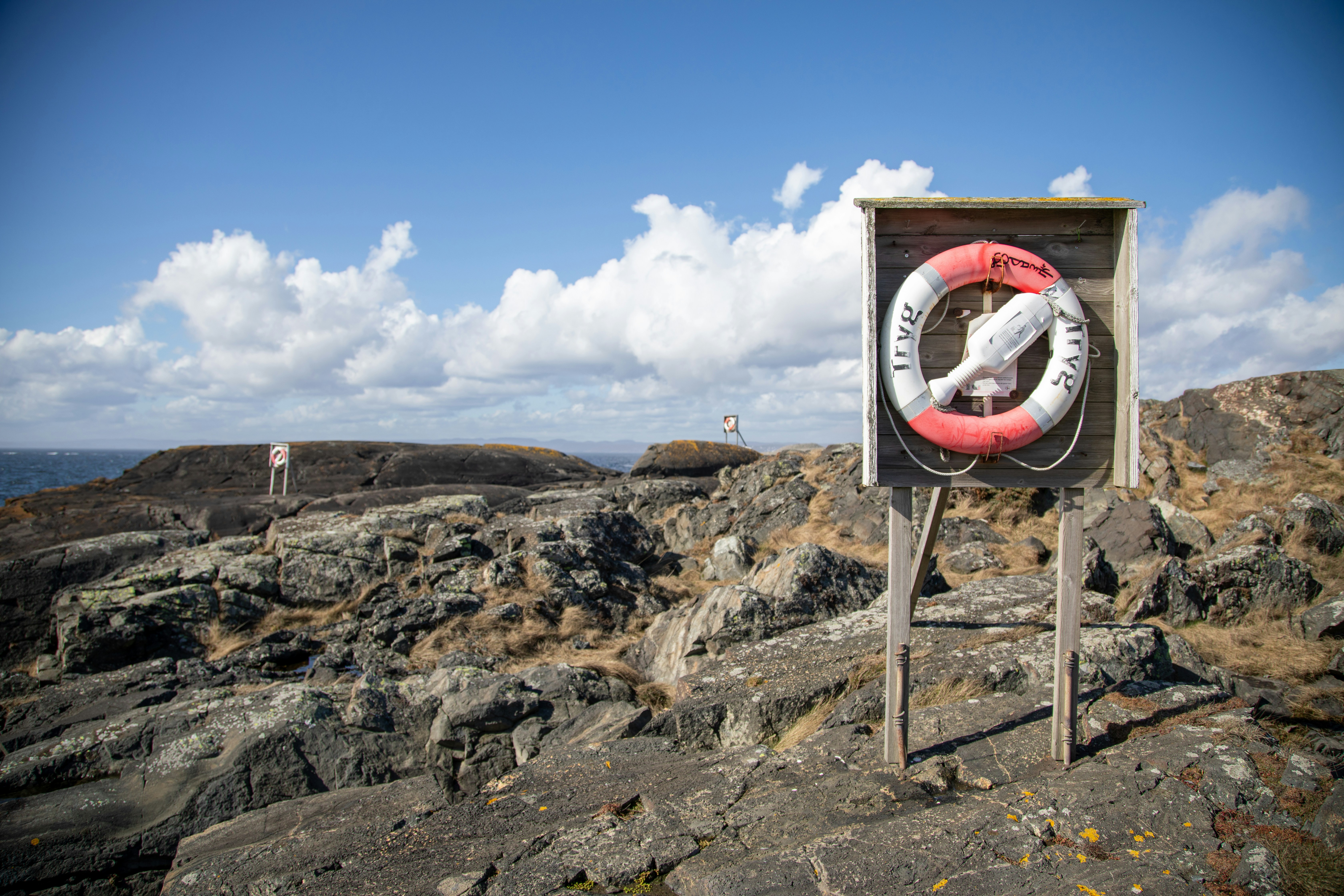 Lifebuoy Sentinel on rugged lava: a coastal warning beacon
