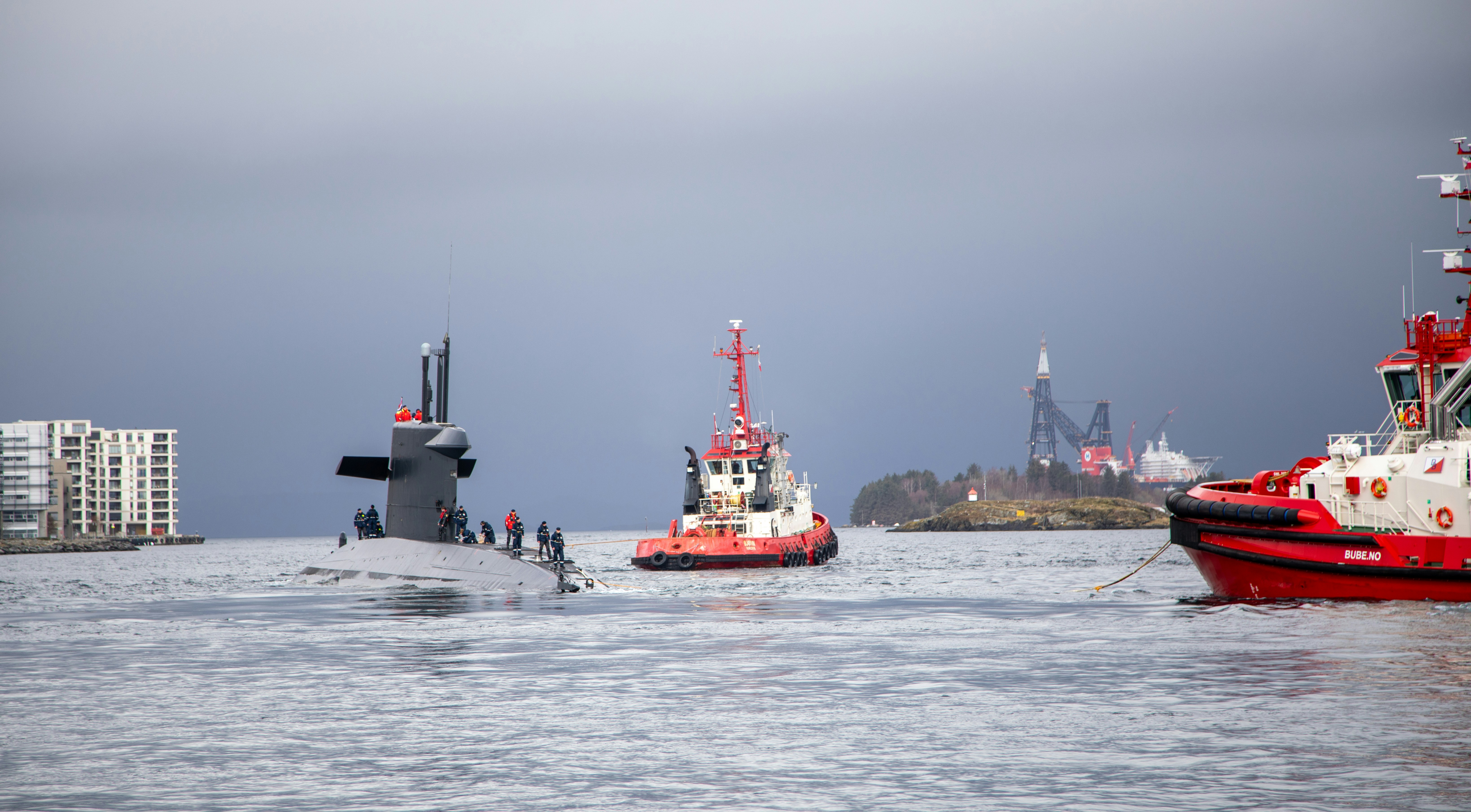 Toward the Harbor: A Red Tug Leads the Way