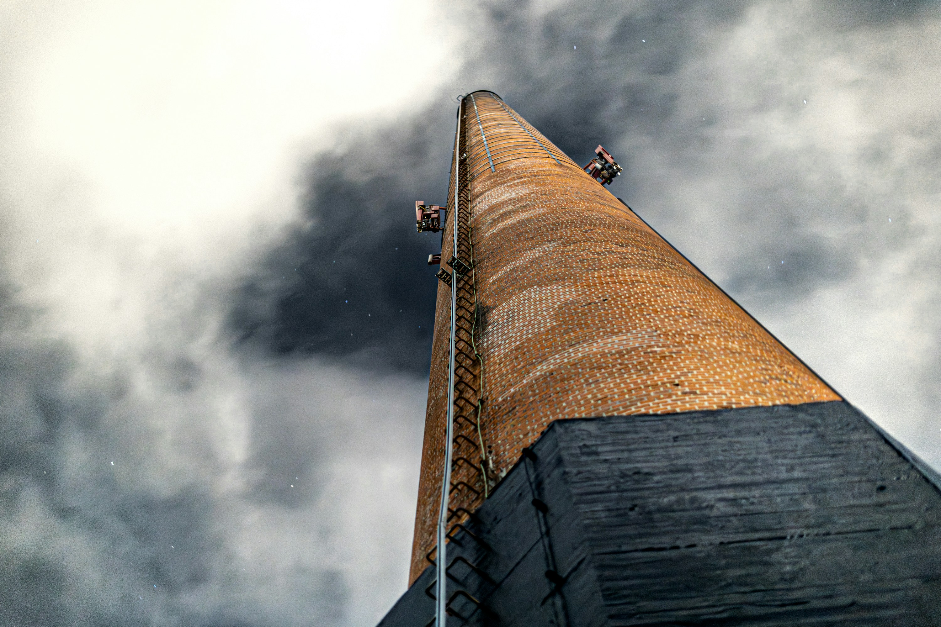 Vertical Ascent: A Rooftop Perspective of a Weathered Brick Tower