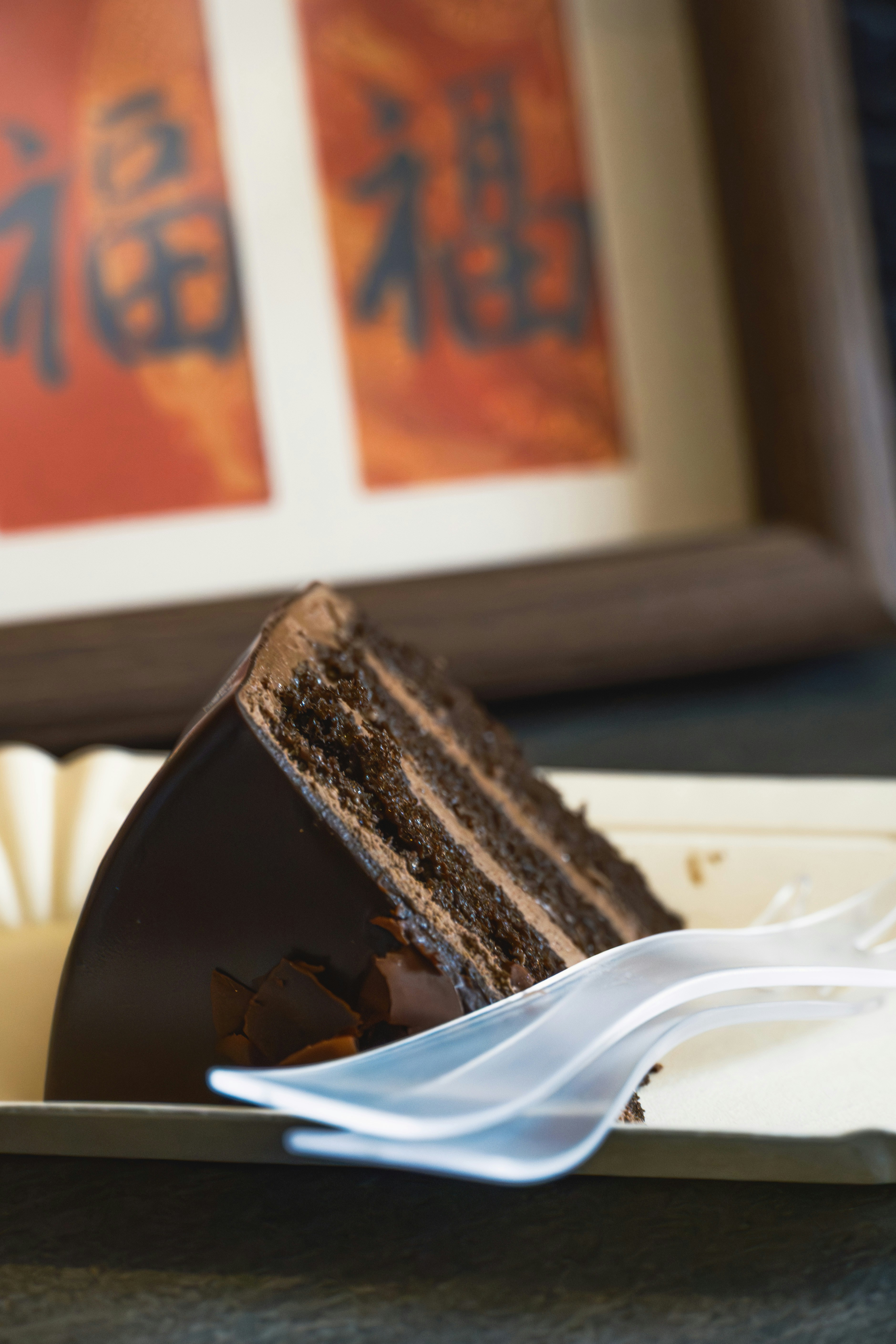 A Rich Slice: Chocolate Layer Cake Slices Across a Gleaming Plate