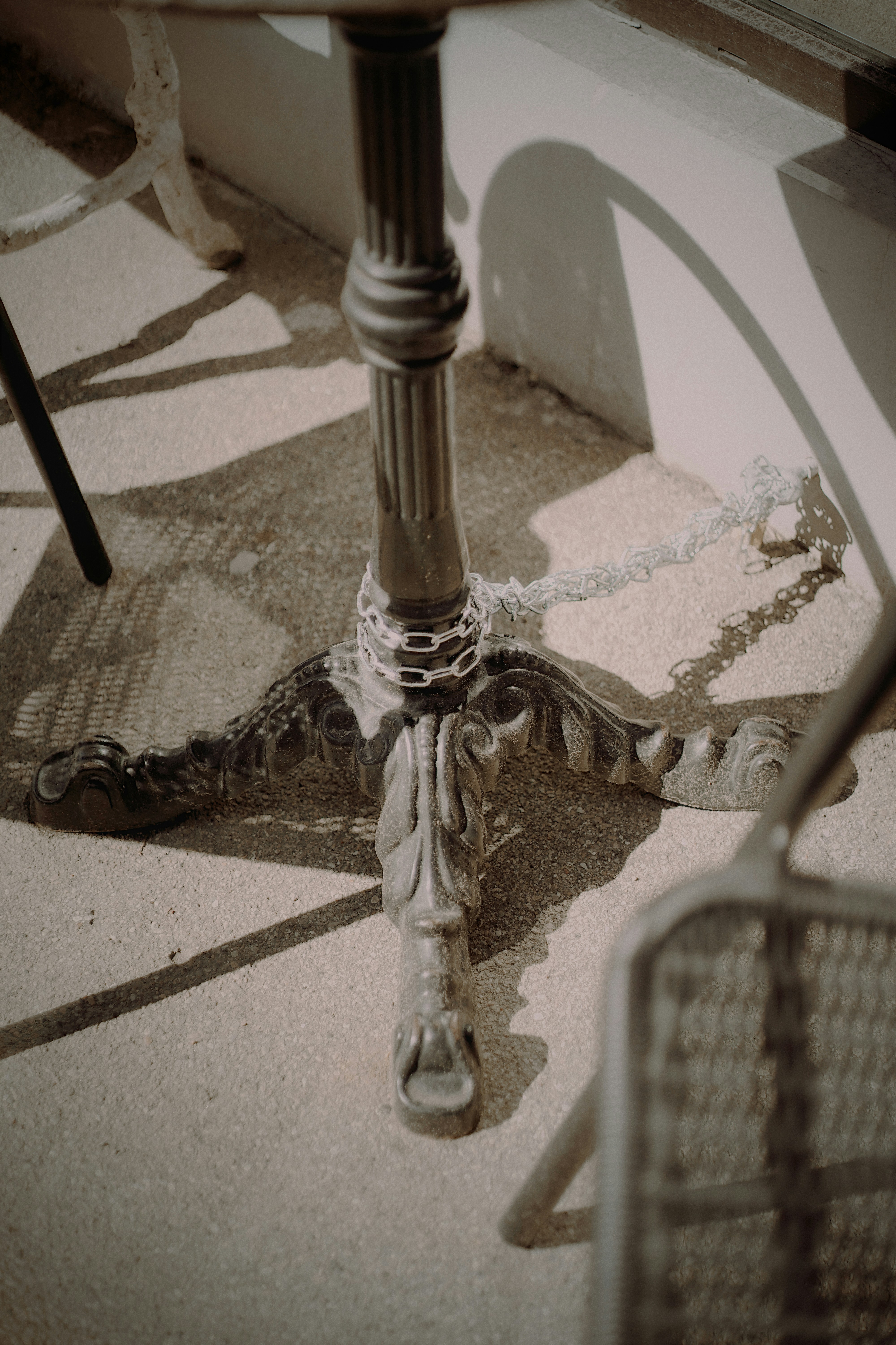 Historic Table Leg and Ornate Base in Sunlit Courtyard