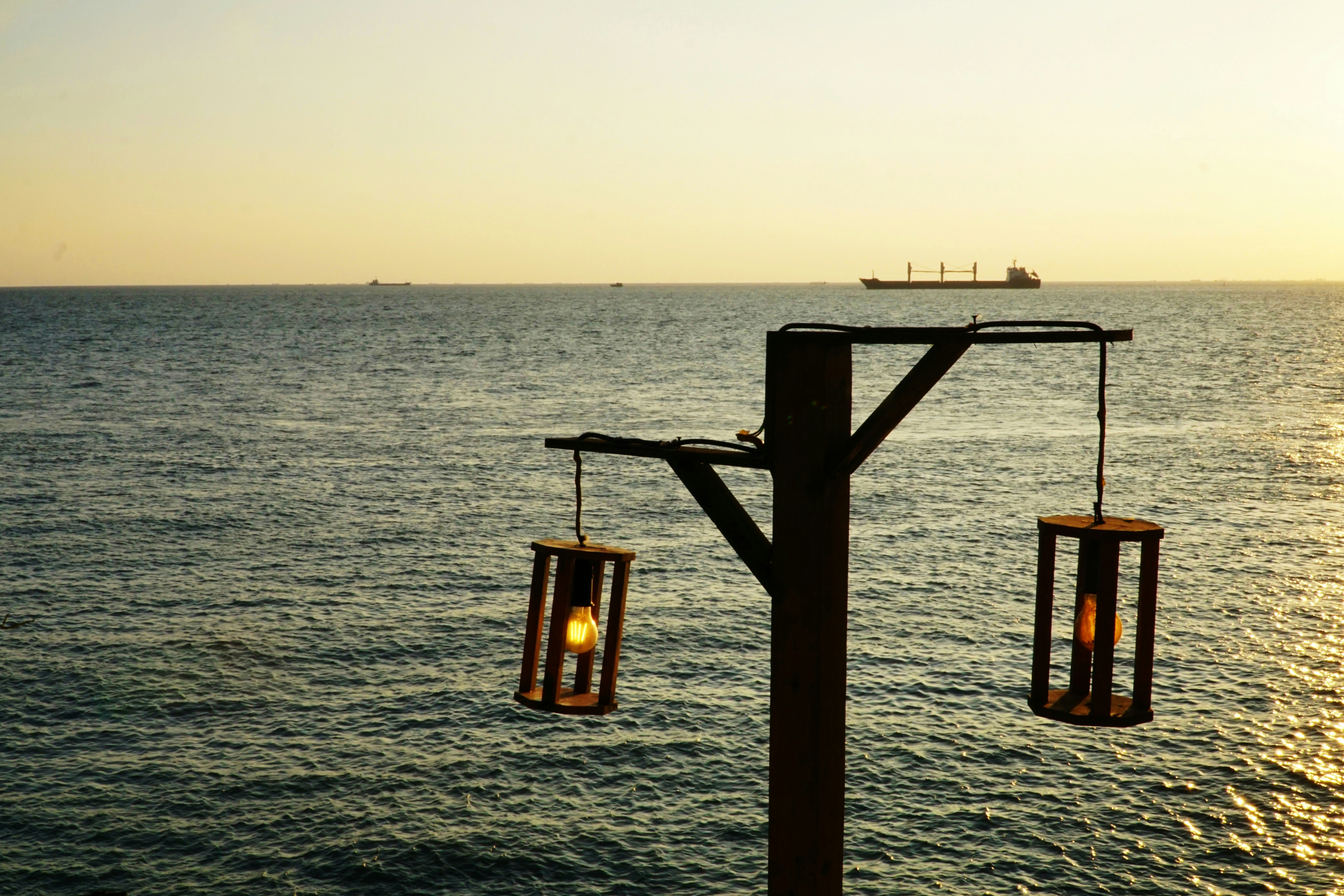 Lanterns at Dusk: A Pier-Top Snapshot Over Quiet Waters