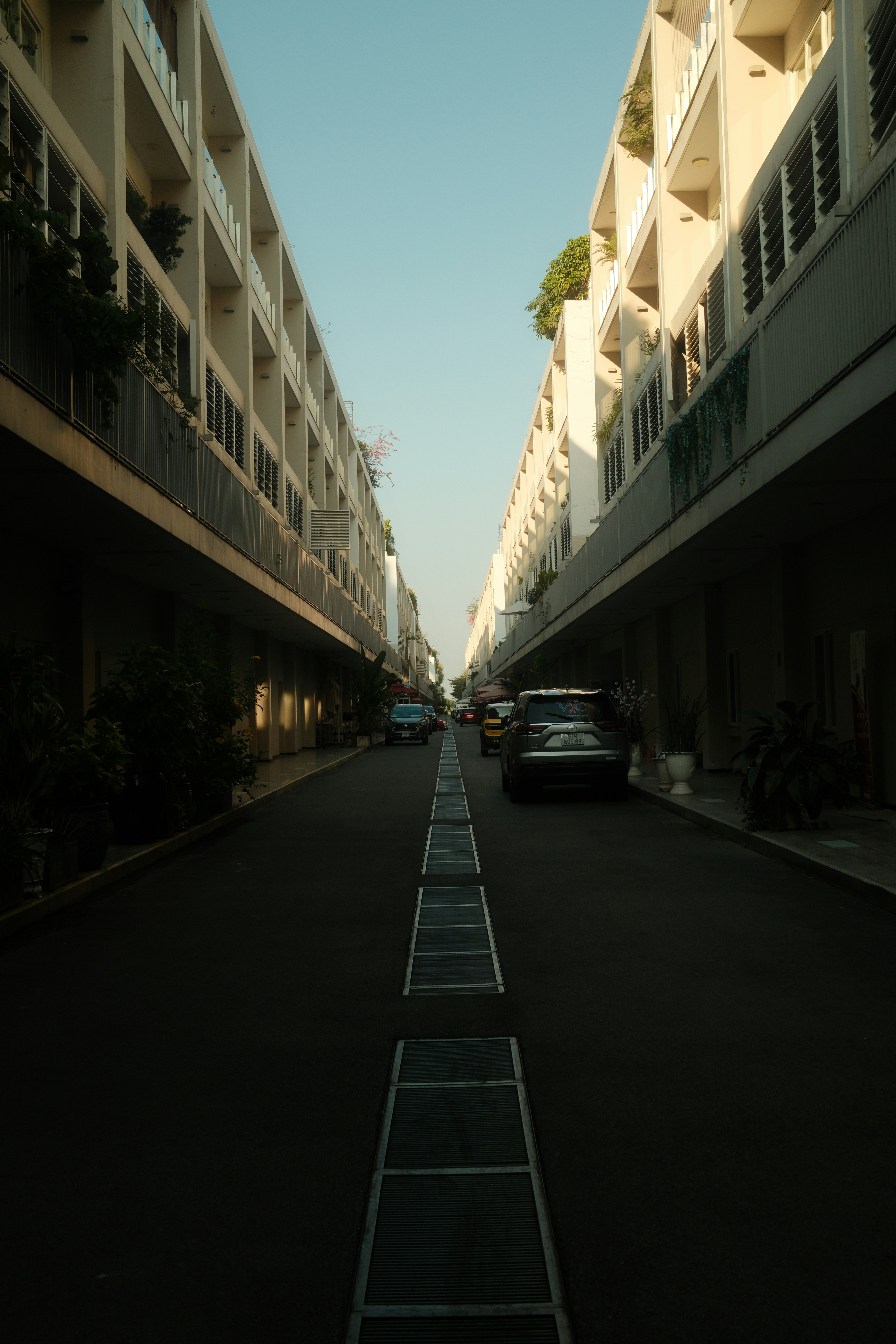 A straight road between two rows of buildings.
