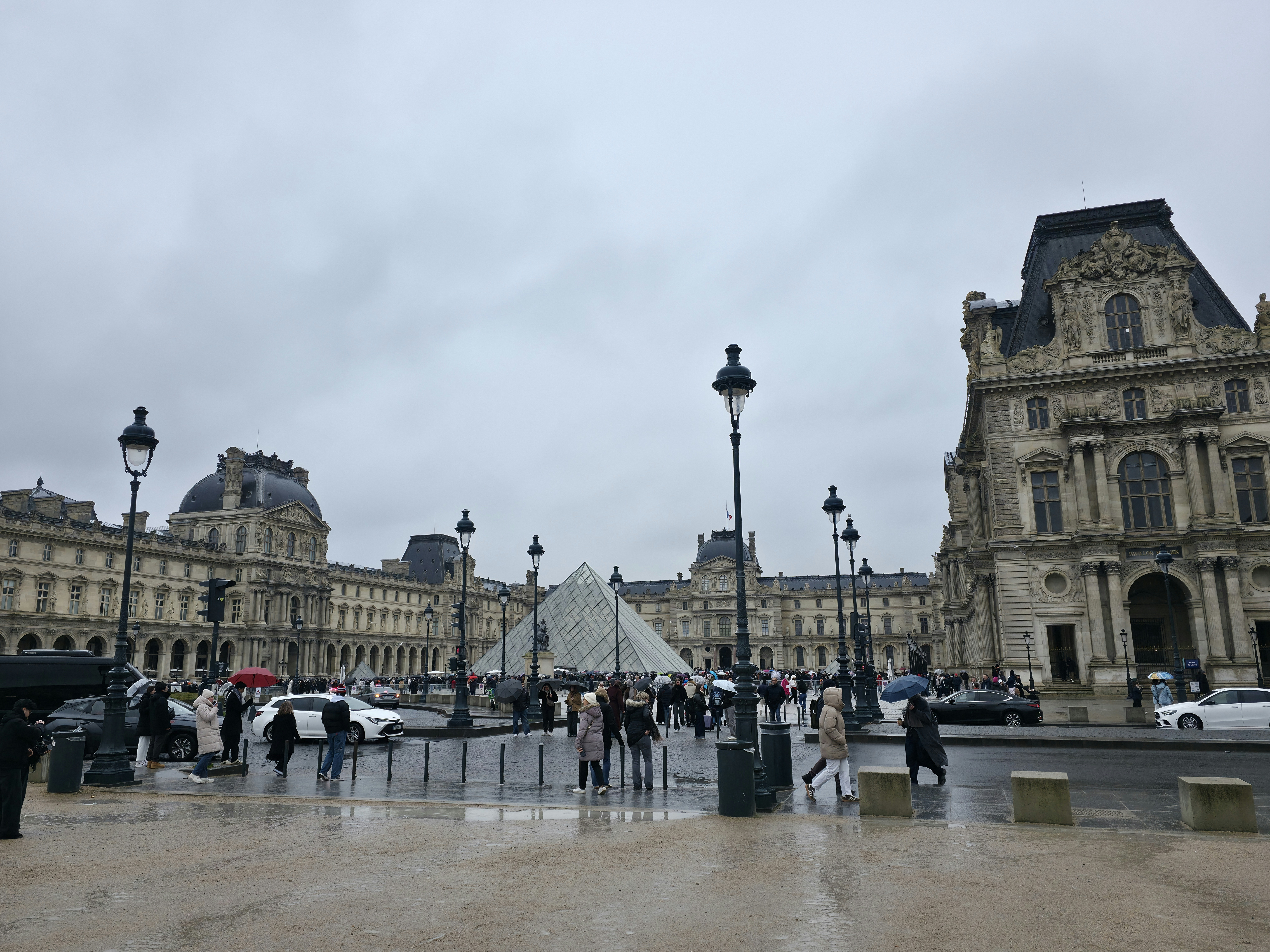  Louvre Courtyard Rainfall: Glass Pyramid and Historic Facades in Focus