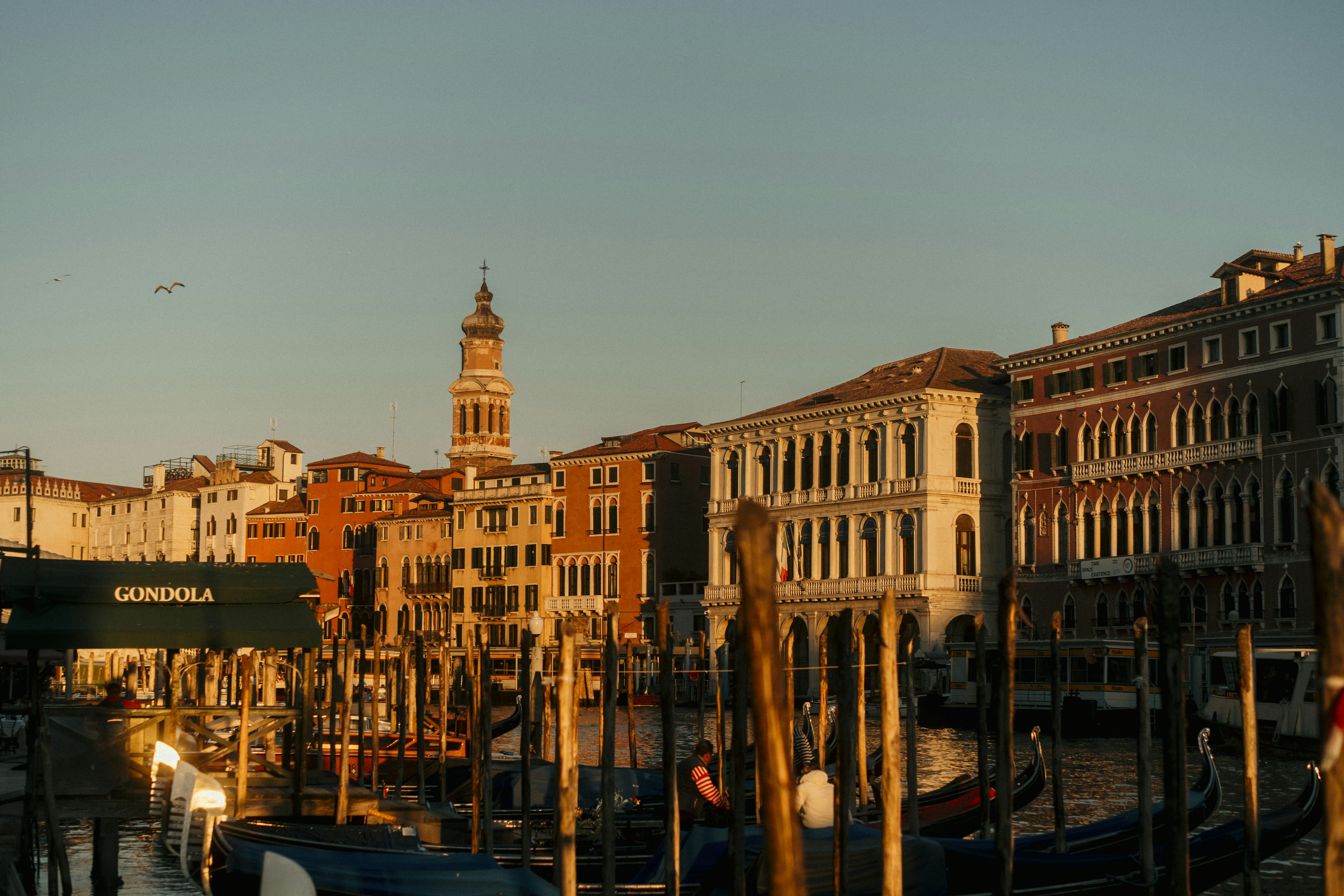 Venetian Glow: Boats, Gondolas, and Historic Facades at Dusk