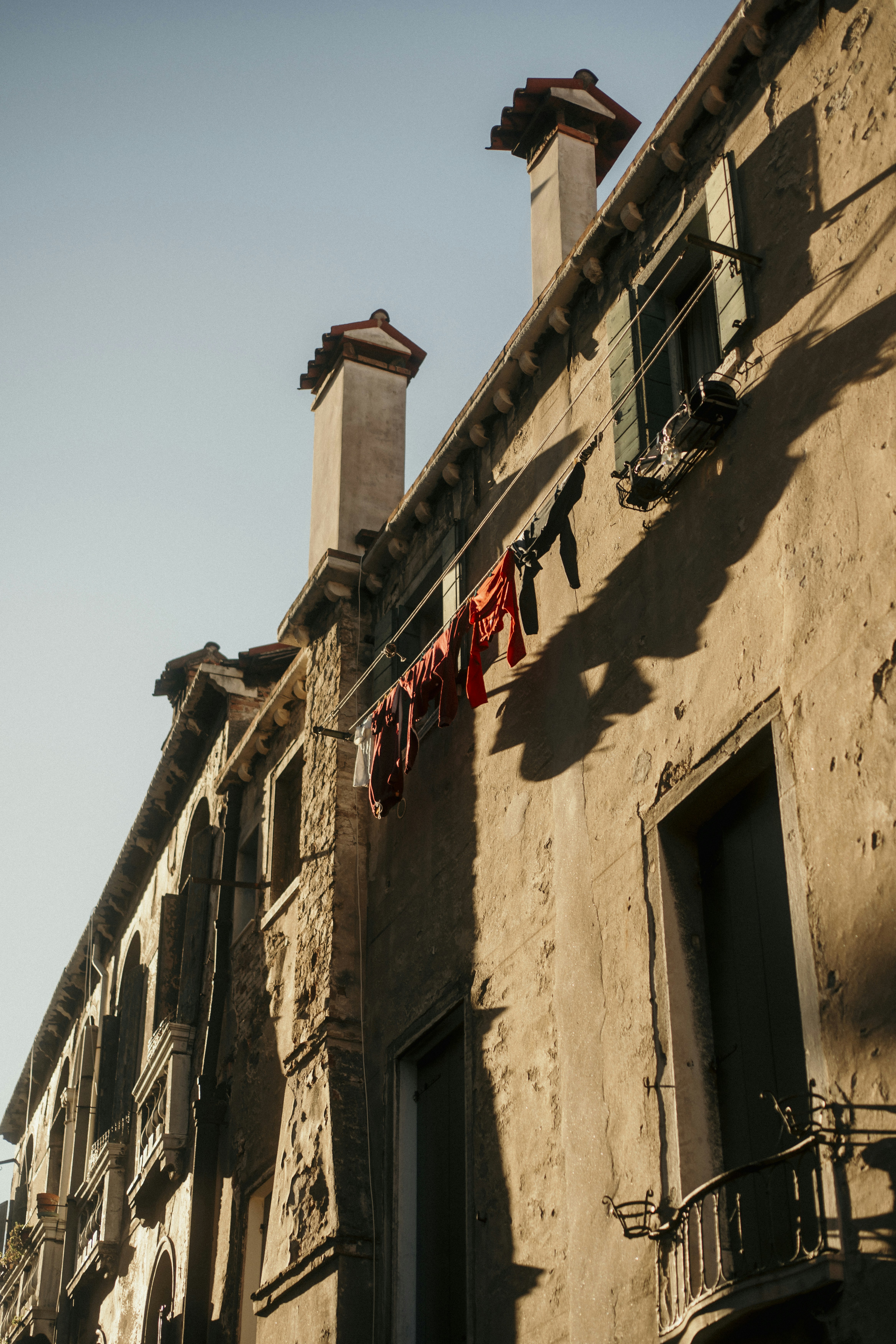 Sunlit Laundry Line Between Weathered Facades