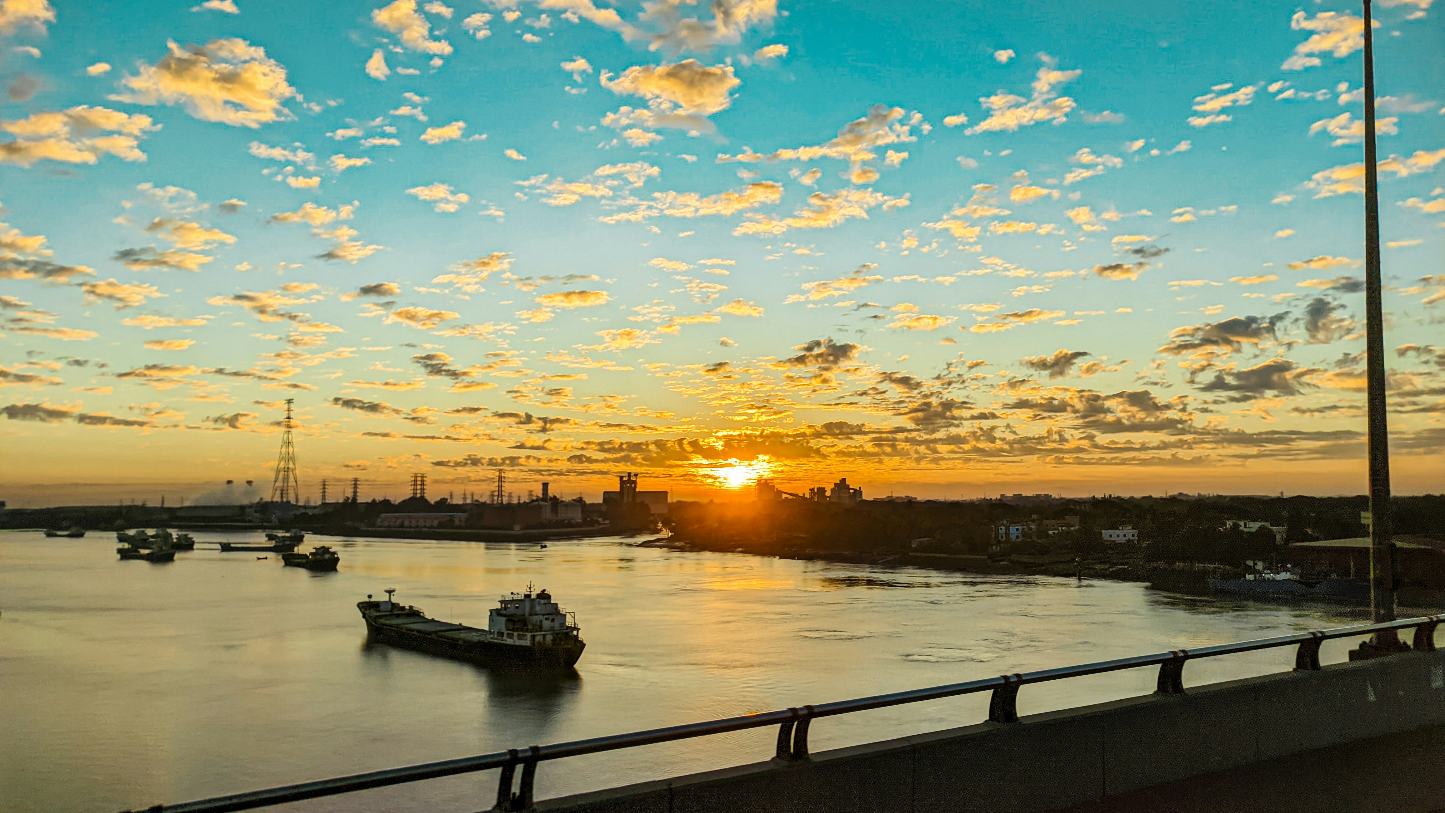 Sunlit Strait: Boats at Dusk Beneath a Kissed Horizon