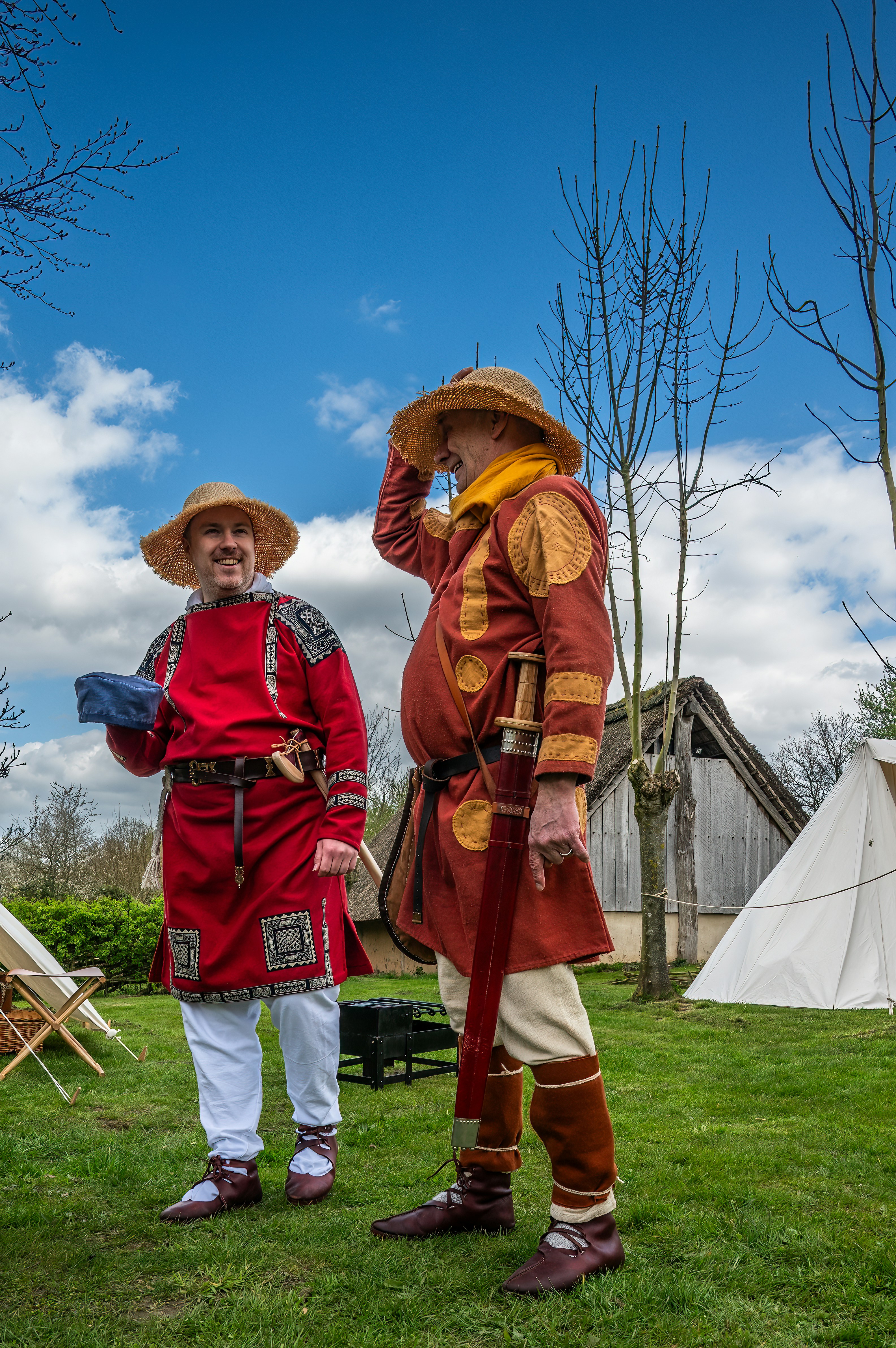 Heritage Reenactment: Two Volunteers in Period Garb Under a Bright Blue Sky