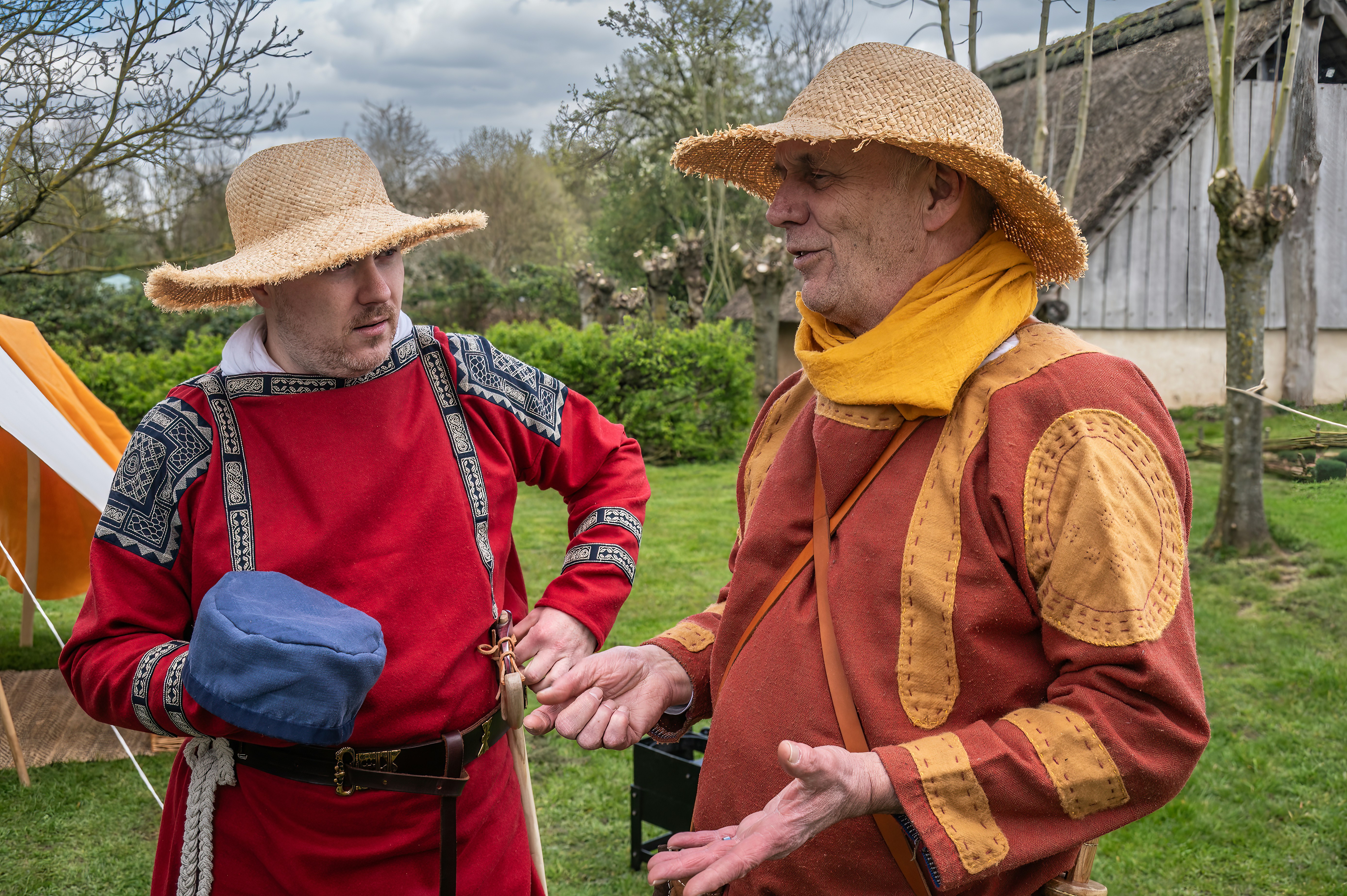 Heralds of the Field: Two Reenactors in Rich Crimson and Sunlit Straw