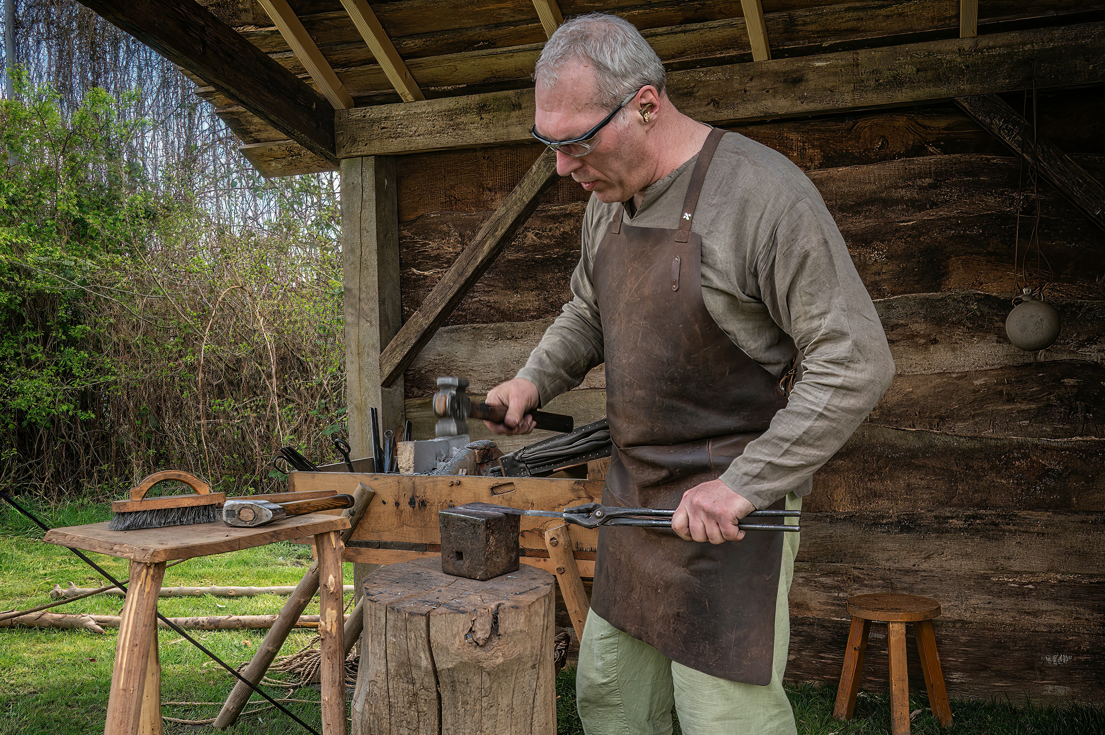 Blacksmith at Work: Crafting Steel by Wood-fired Glow