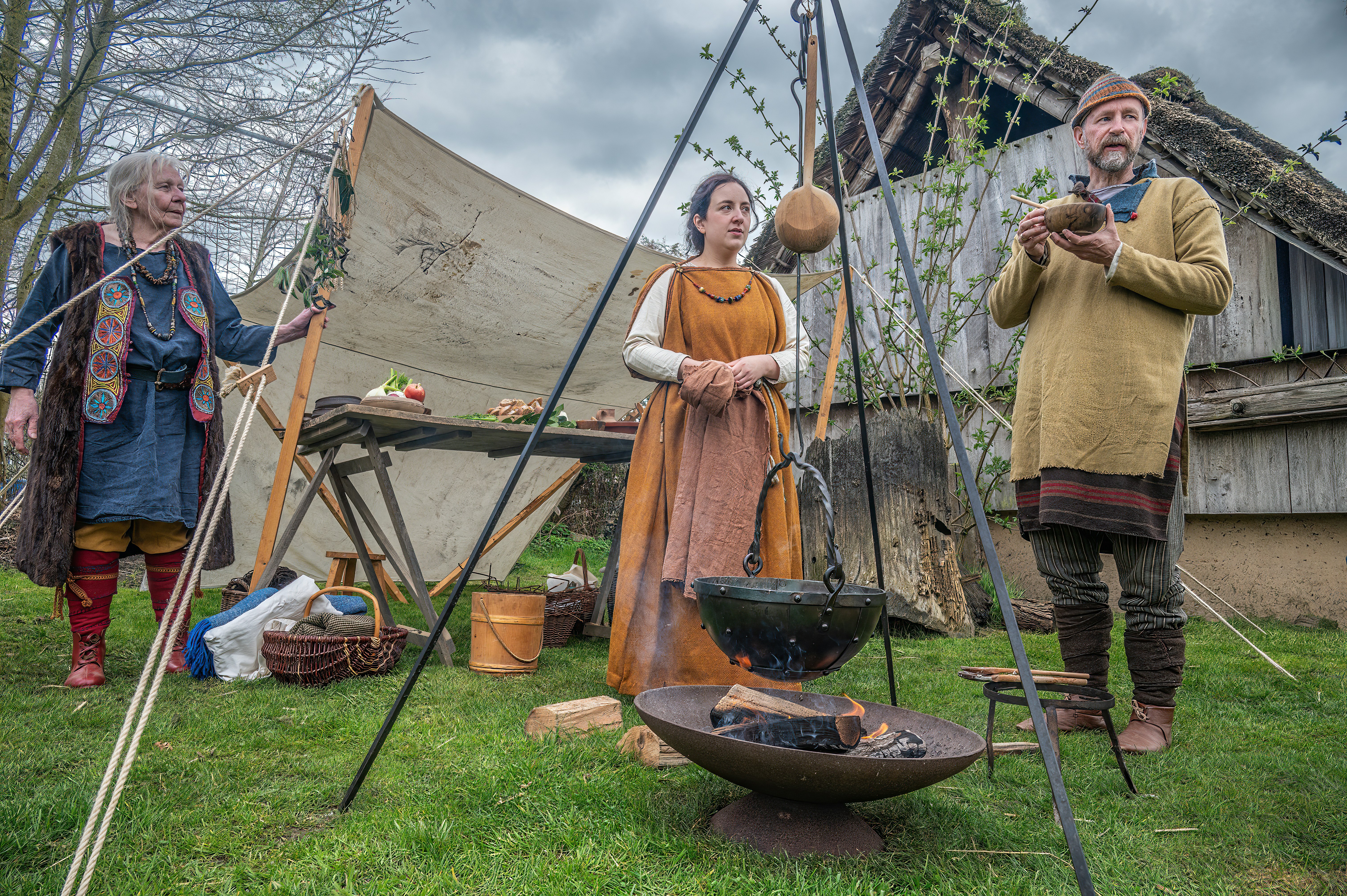Medieval Campfire Portrait: Three Wanderers Around a Hearth