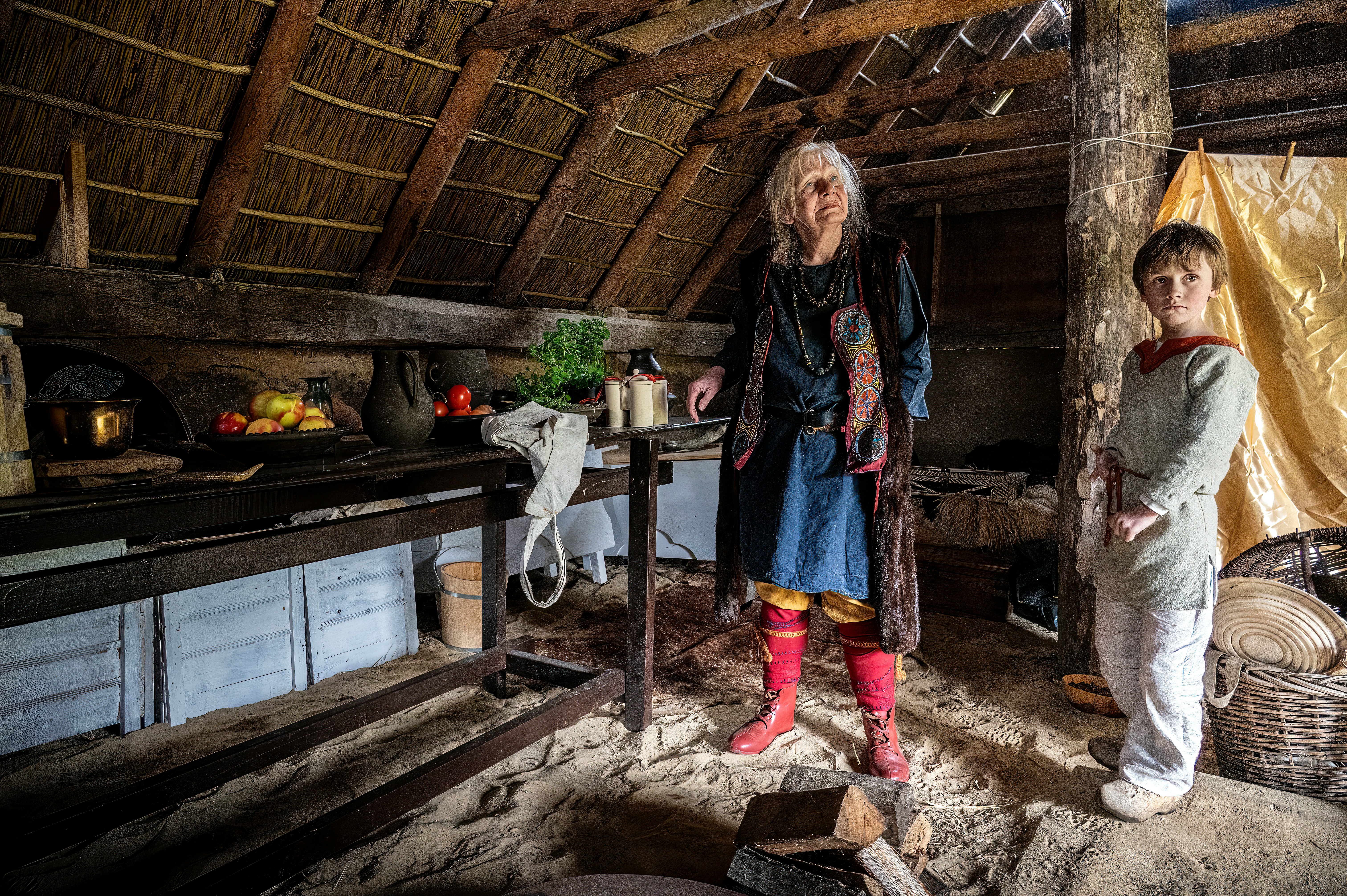 Inside the Sand-Cave Kitchen: A Pair of Figures in an Eccentric Rustic Room