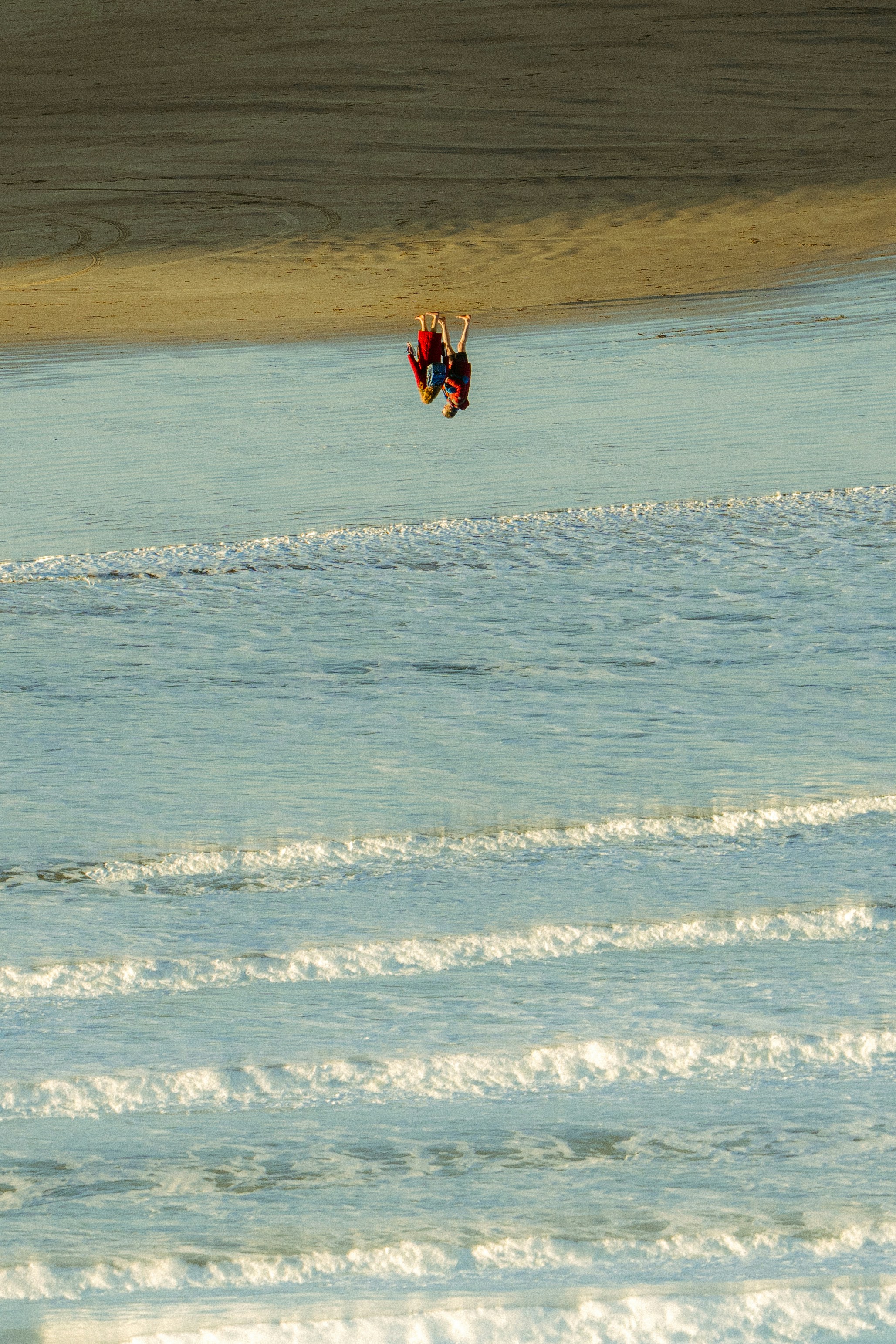 Upside-Down Shoreline Duo: A Quiet Moment on the Tide