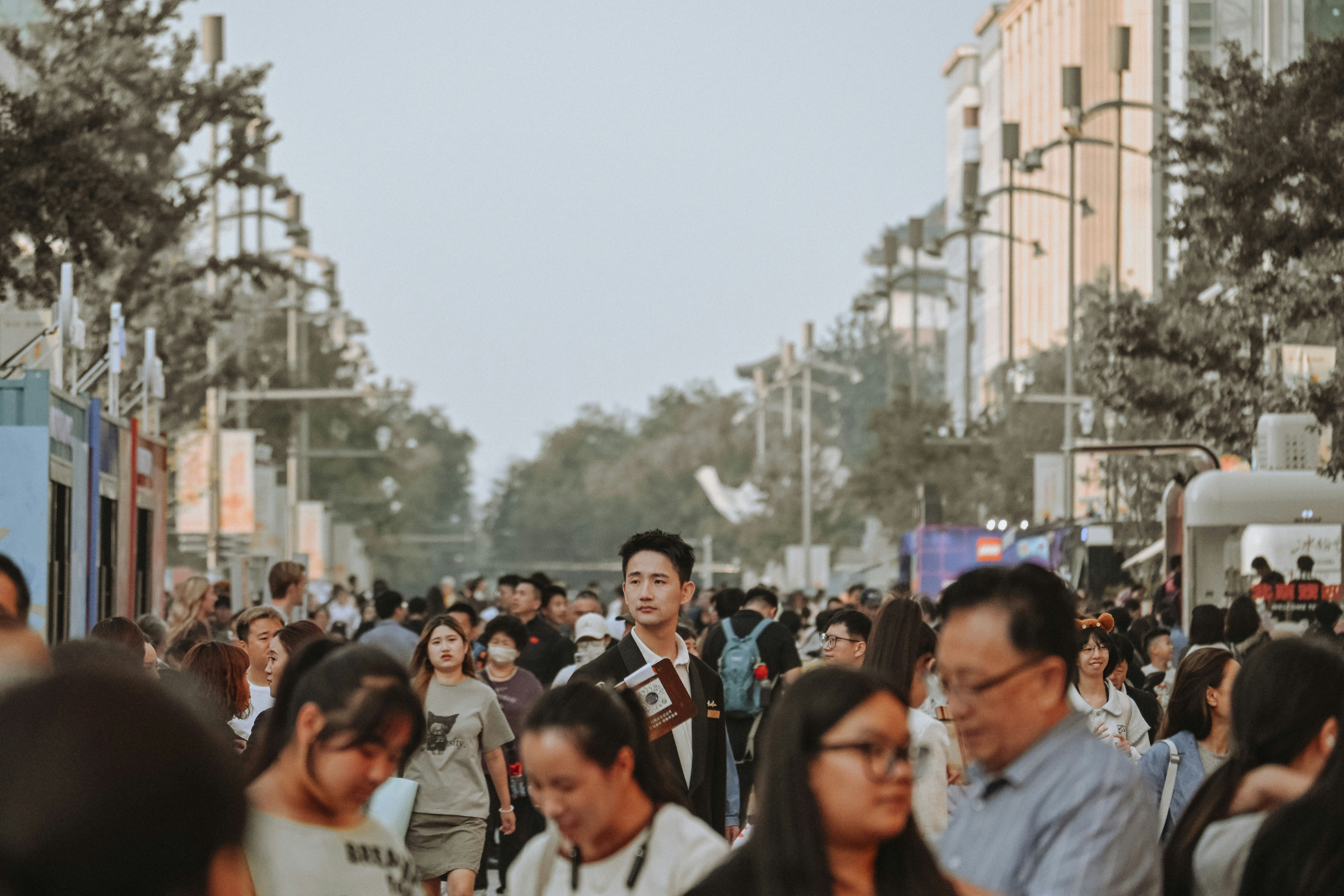 Crowd Pulse: A Quiet Moment Amid a Distant Gaze