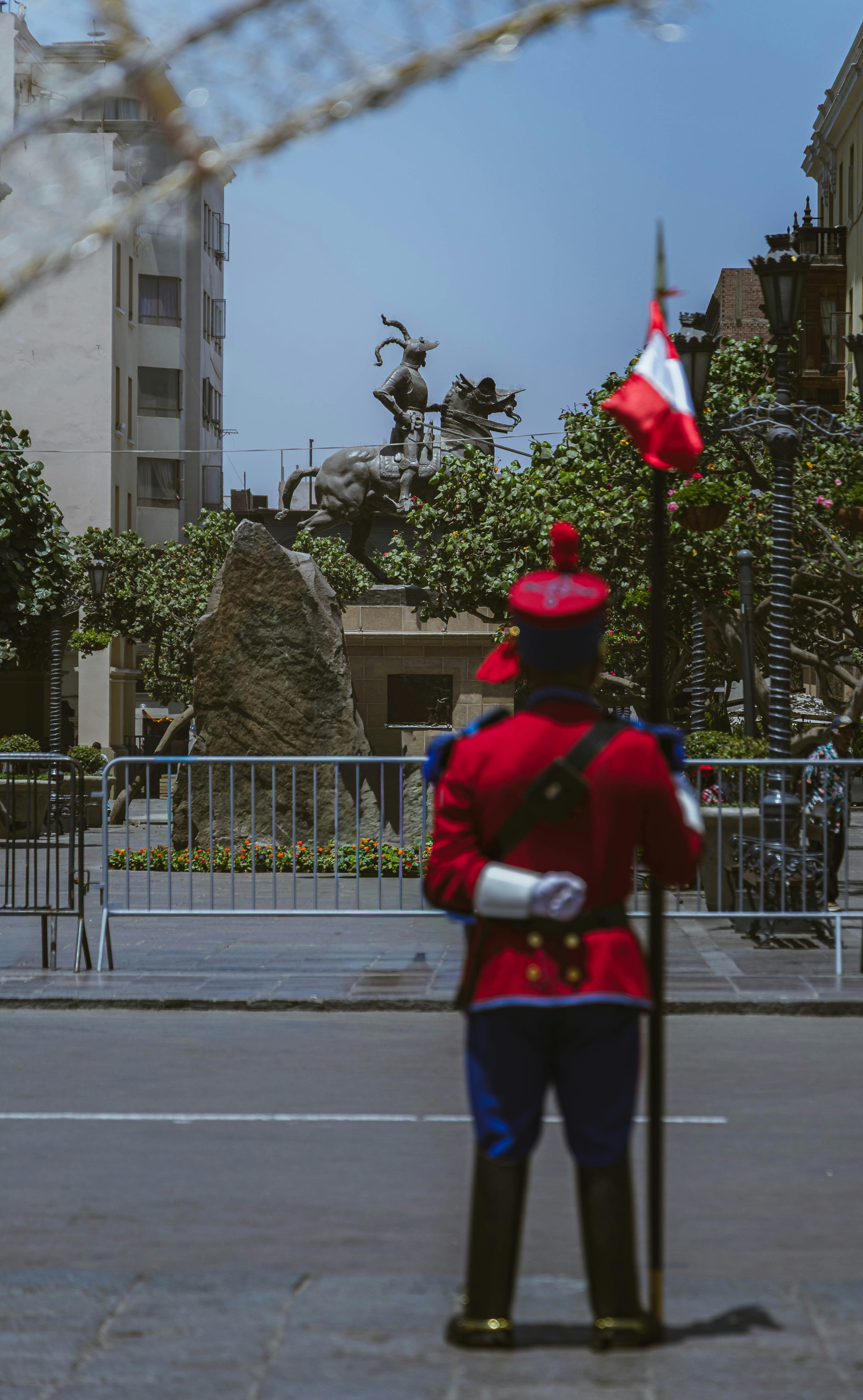 Red-Uniform Guard at a City Monument