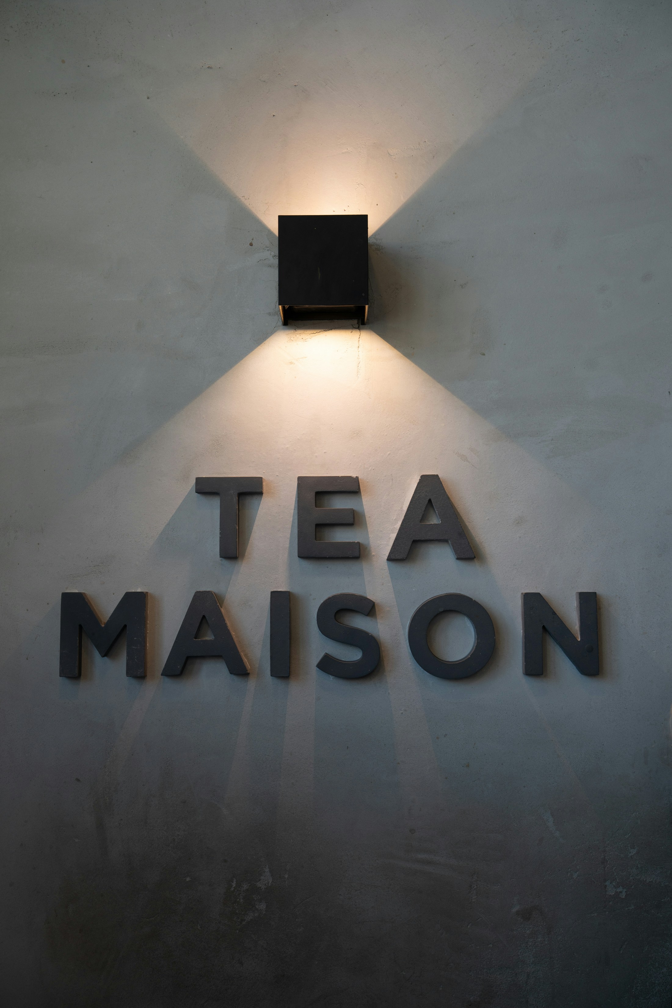 Light Converges on a Pale Facade: TEA MAISON Illuminated