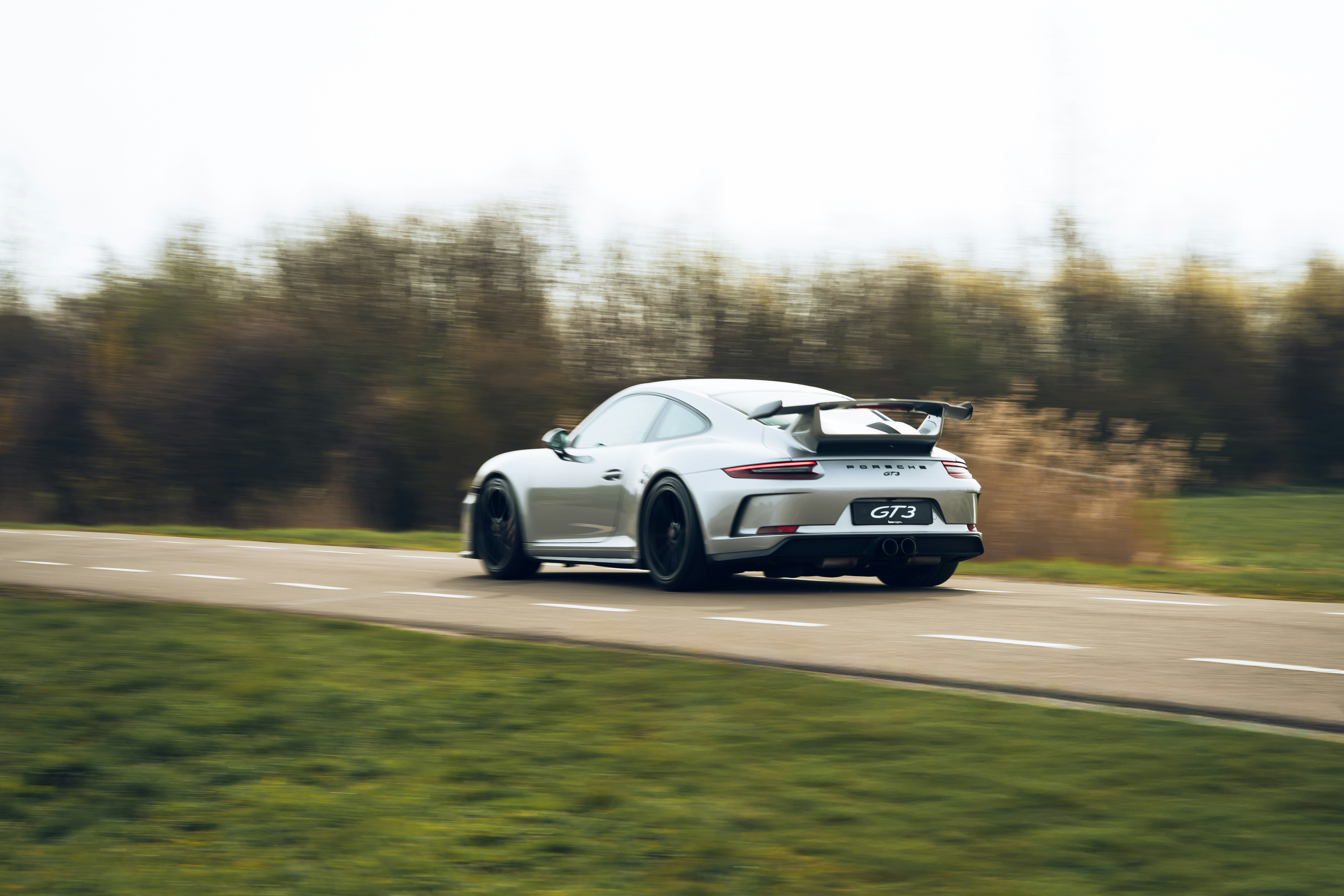 White Porsche GT3 in motion: blurred track & speed blurred background