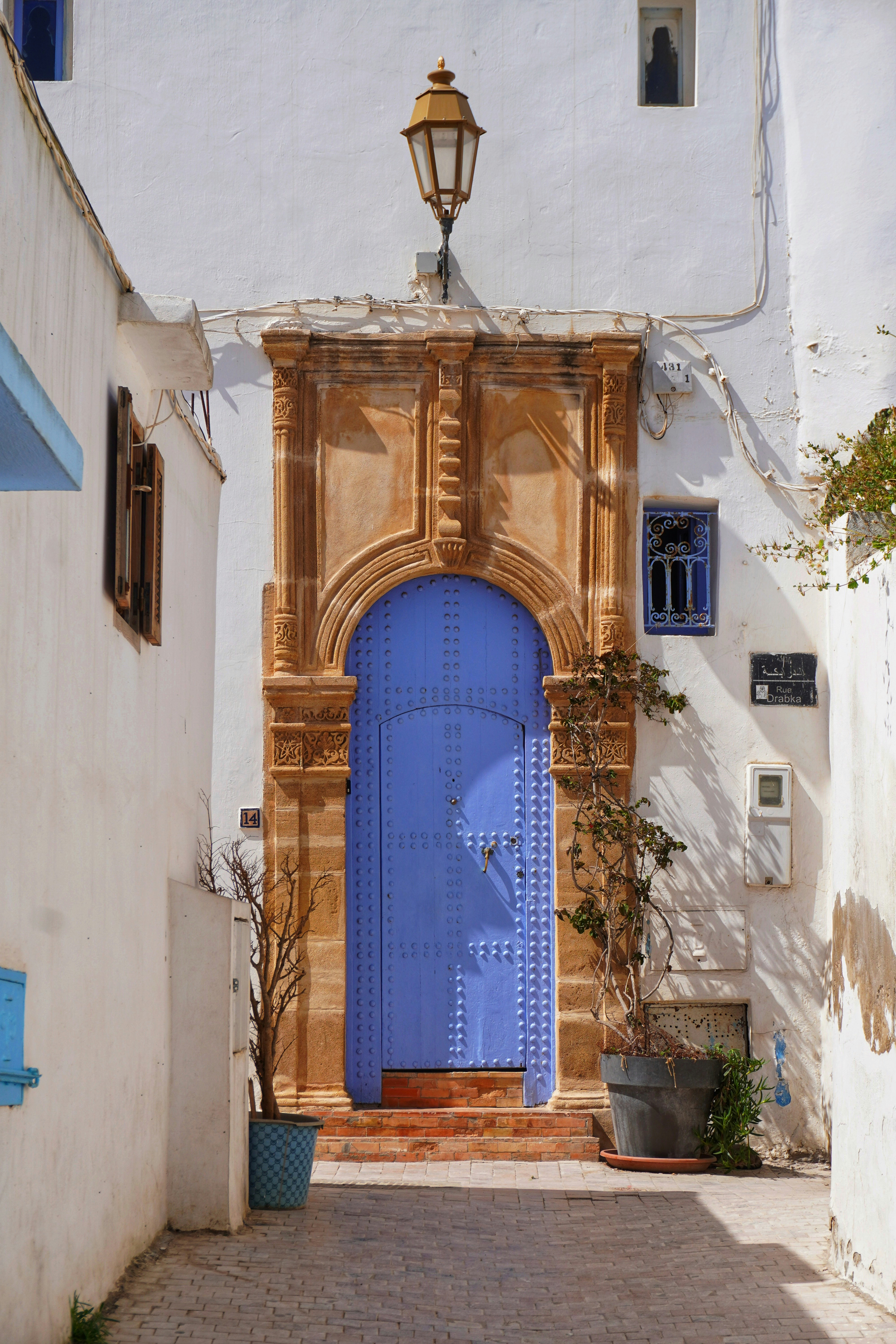 Azure Doorway in Warm Stone: A Tunisian-Jaïs Scene