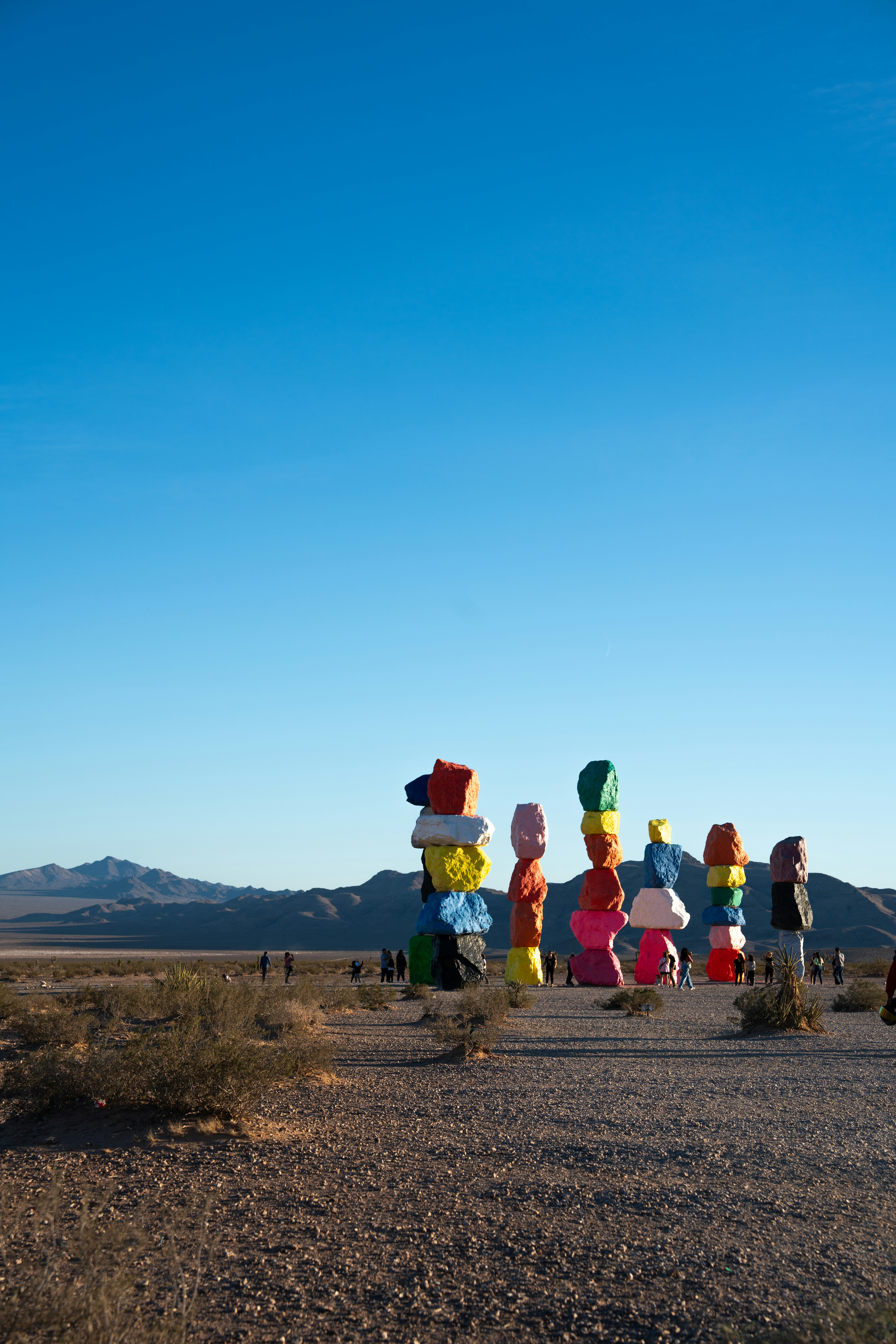 Colorful balancing act: stacked rock sculptures rise against a desert horizon
