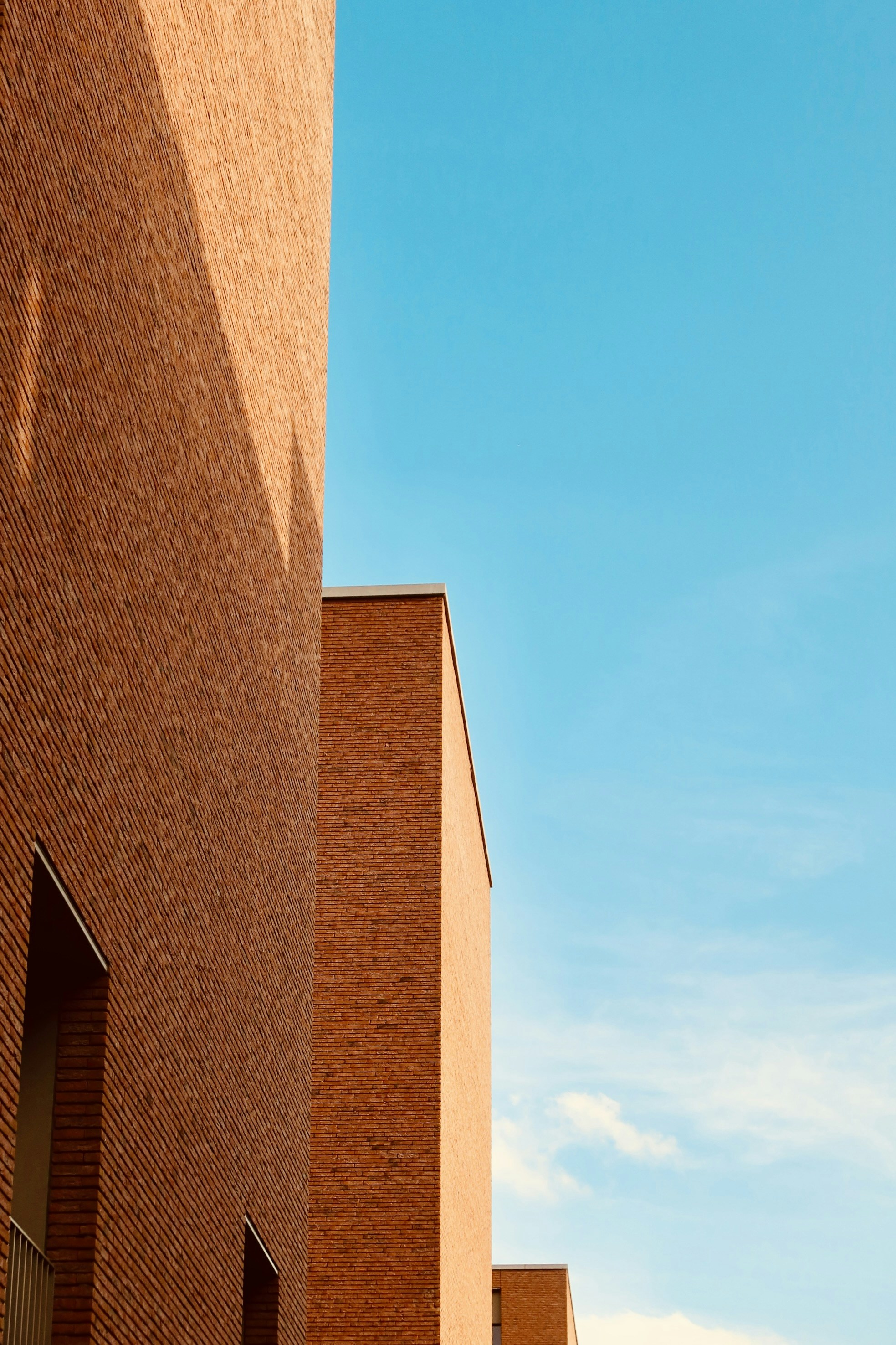 Brick Facades Against a Blue Sky: A Minimalist Urban Cut