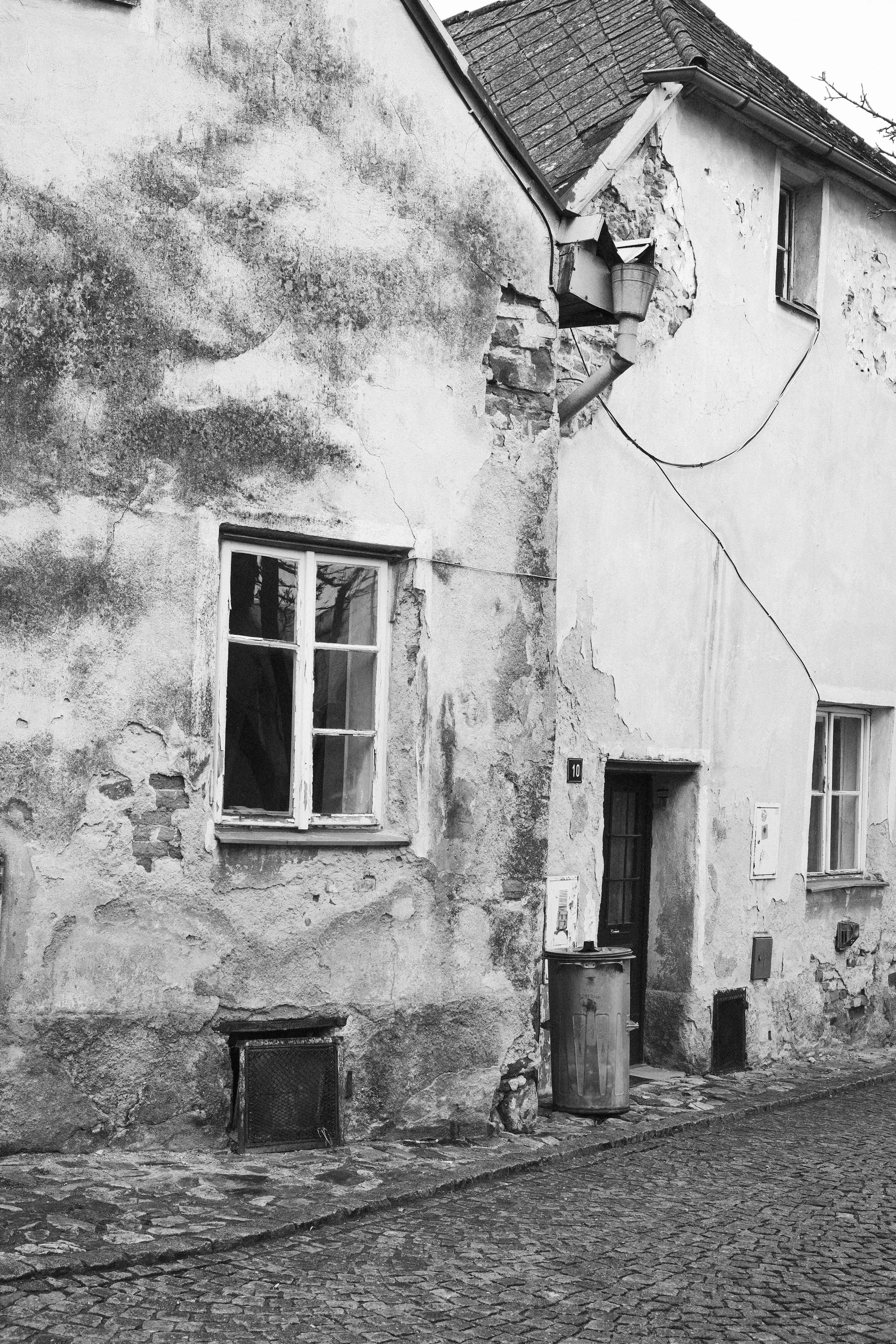 Weathered Facade at the Bend in the Cobbled Street