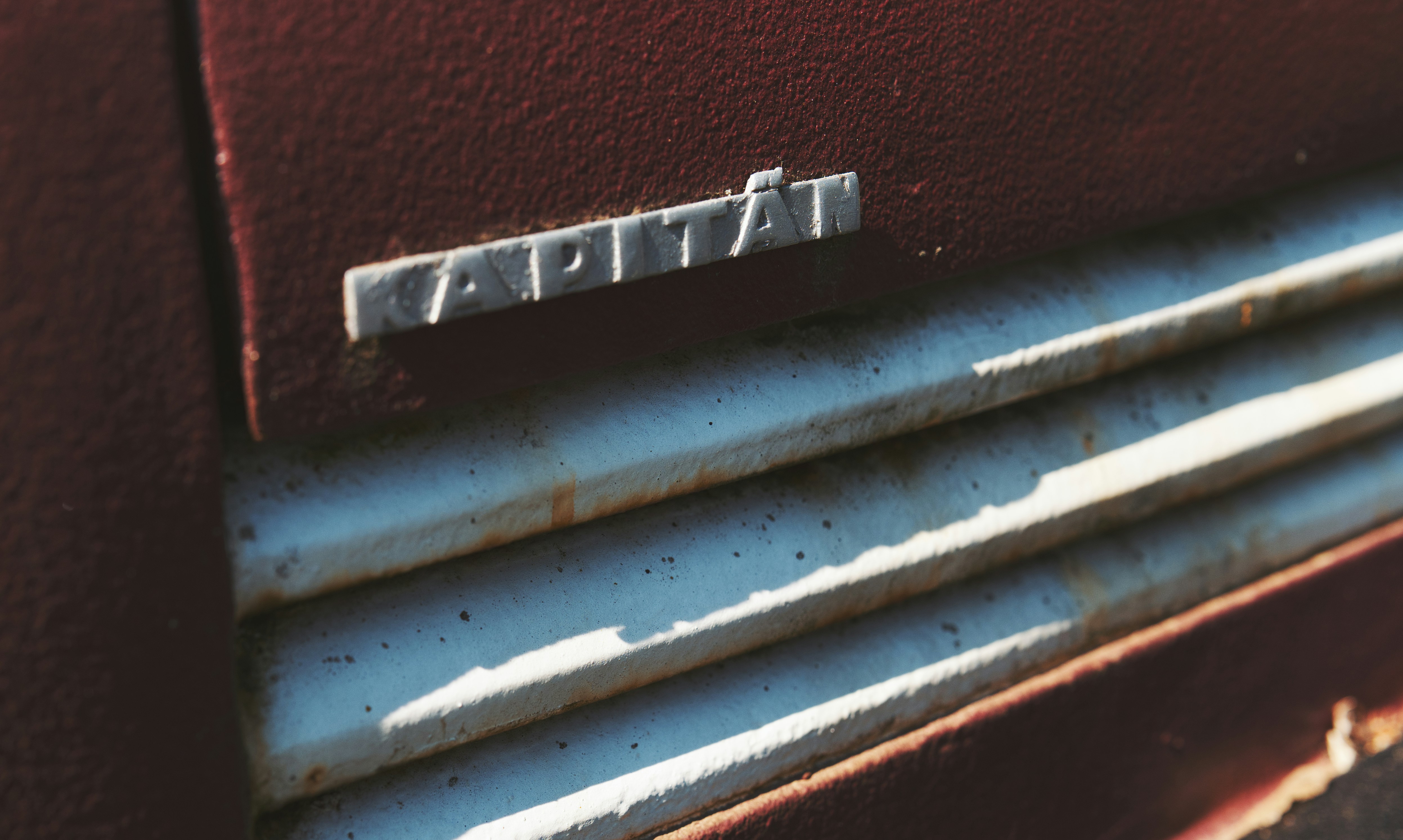 Rust Telltales: The Badge Above a Corrugated Memory
