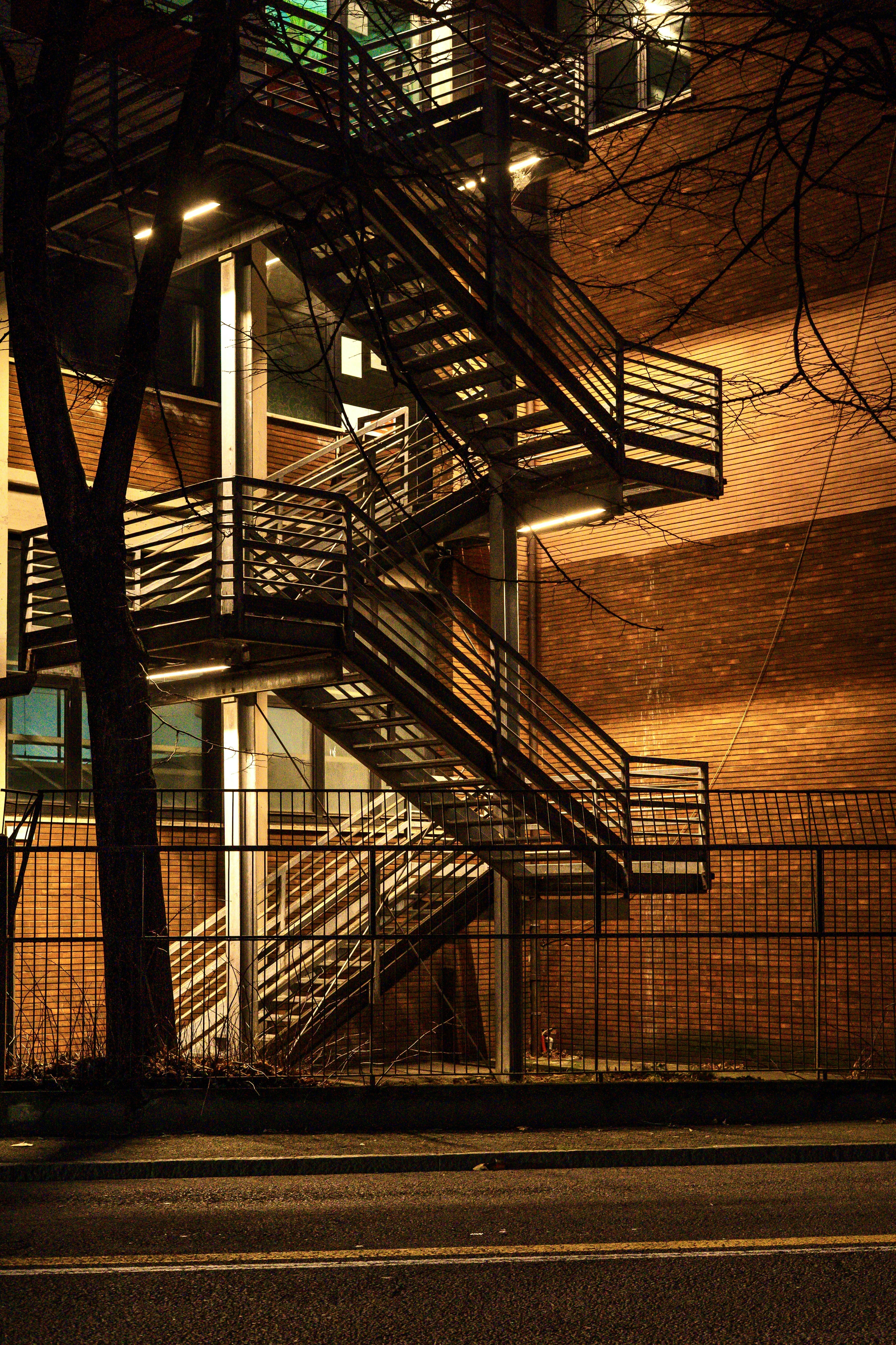 Nighttime Staircase Lanterns: Industrial Geometry Against Brick