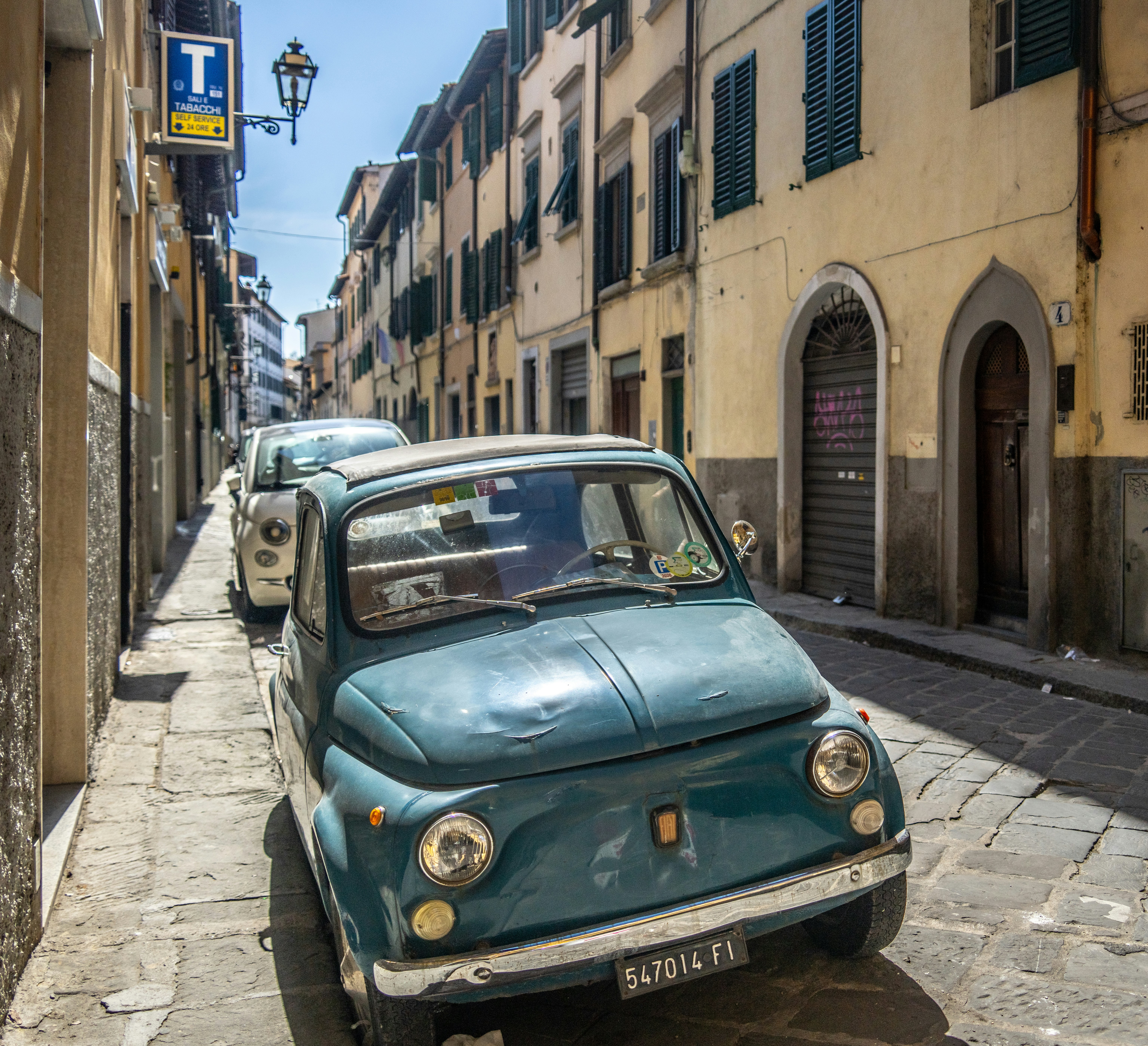 Teal Fiat on a Sunlit Italian Calle