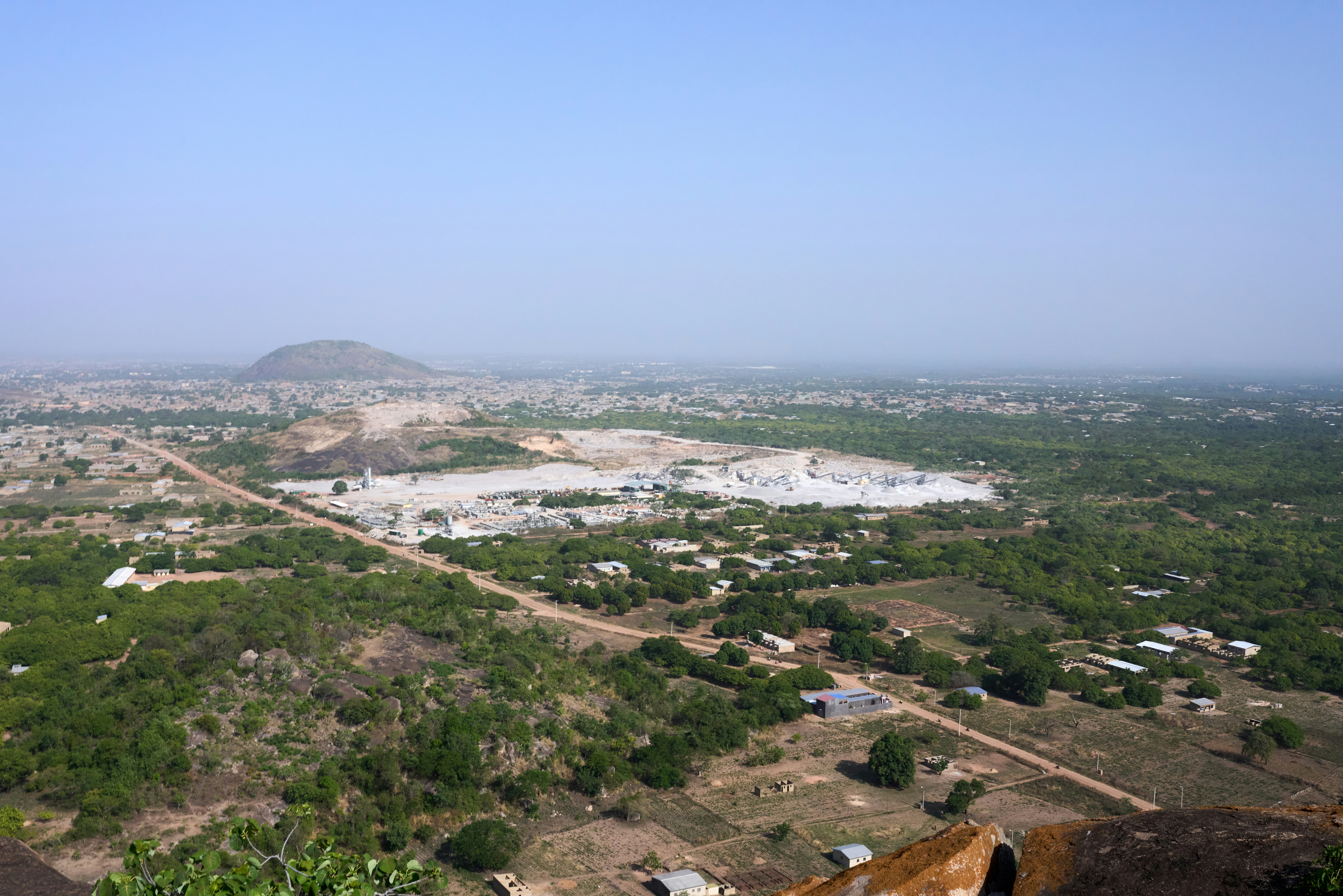 Desert landscape with distant quarry and winding road