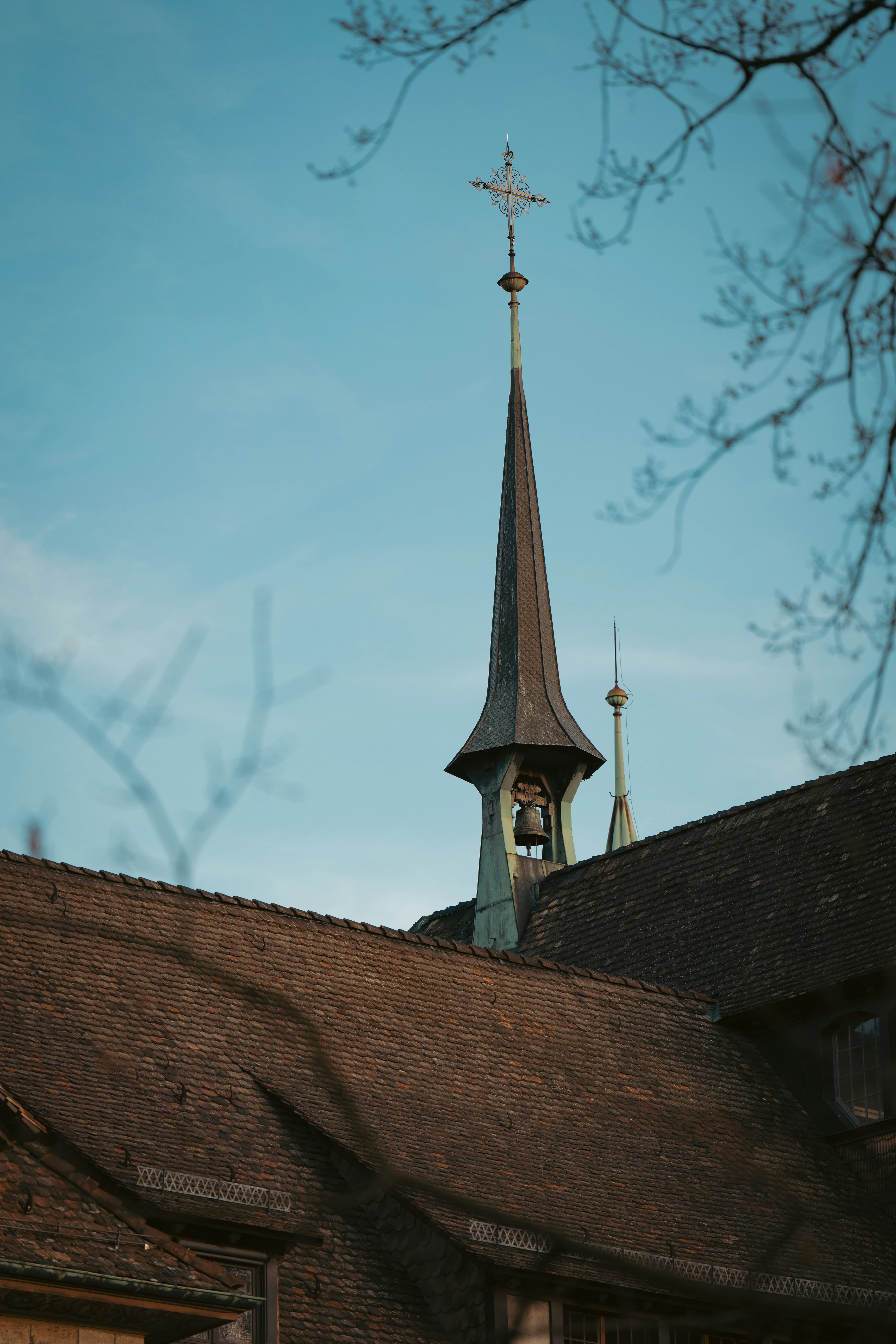 Spire Silhouette Rising: A Rooftop View Toward the Narrow Bell Tower