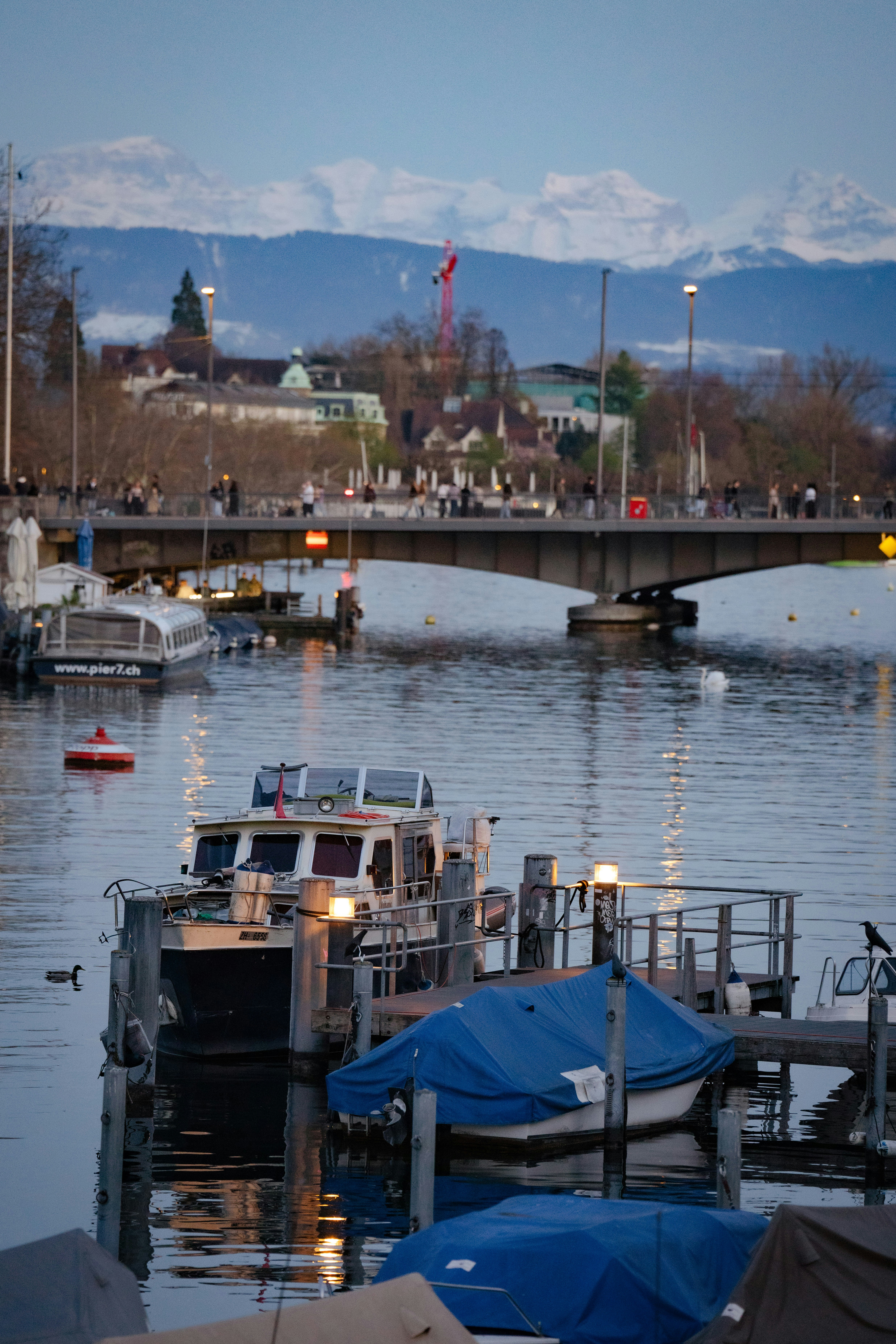 Boats at Rest Under a Snow-Capped Horizon