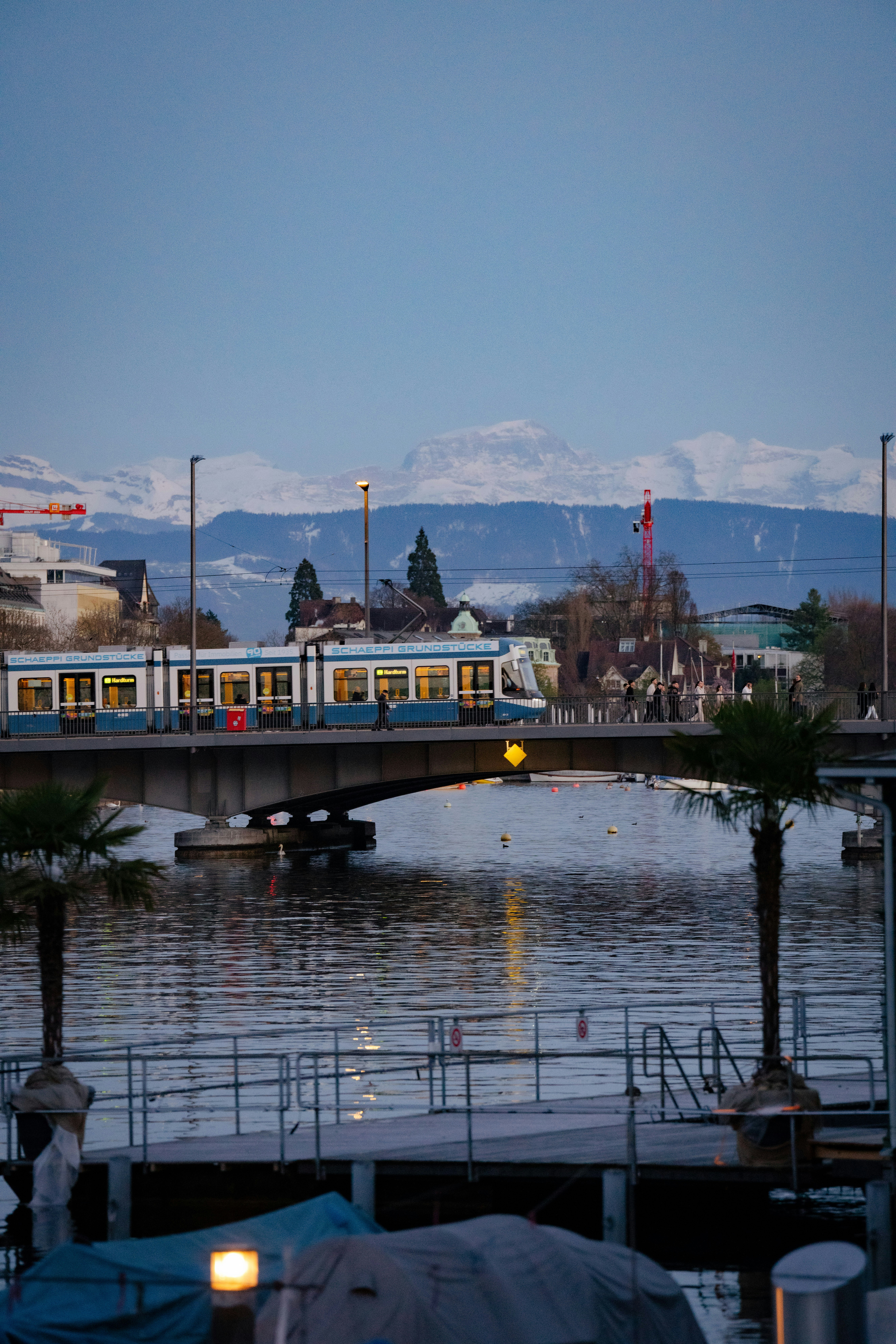 Blue Train Crossing Over Quiet Waters
