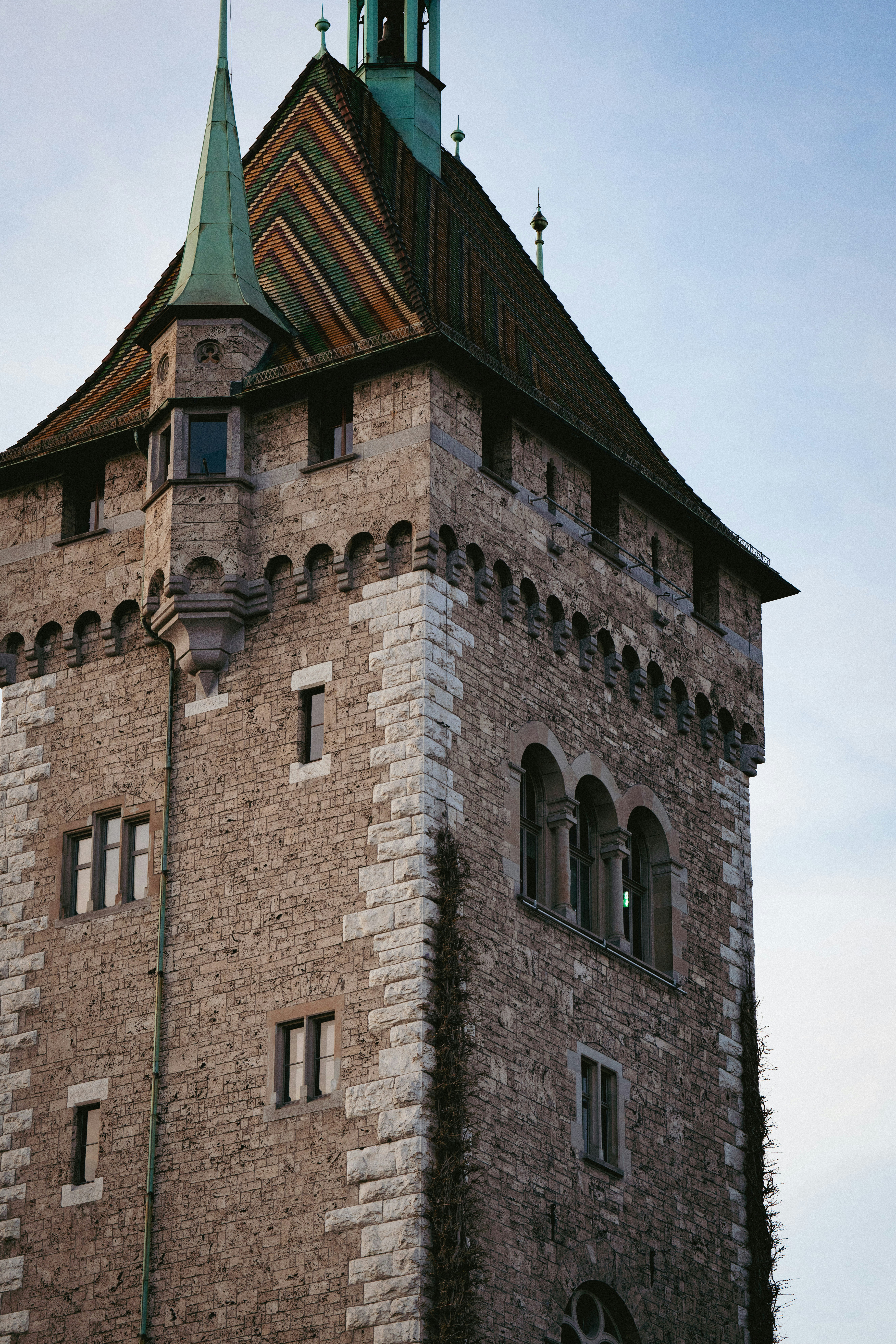 Stone Turret Under a Tiled Roof Reaching Toward a Clear Sky