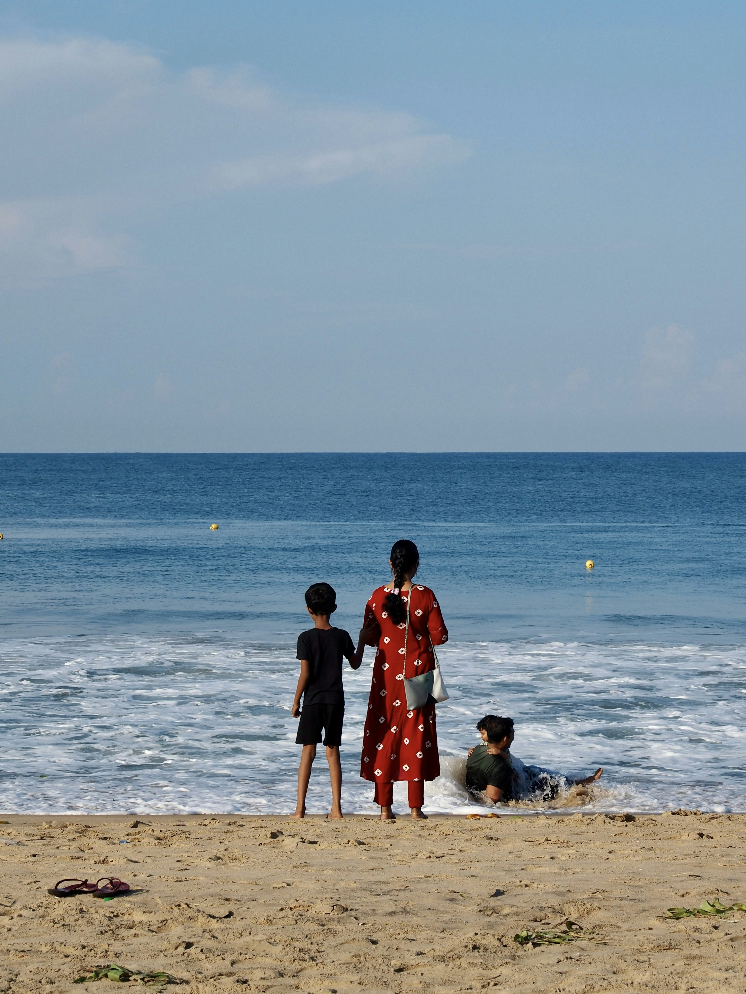 Family at the Seashore: A Red Dress and Quiet Waves