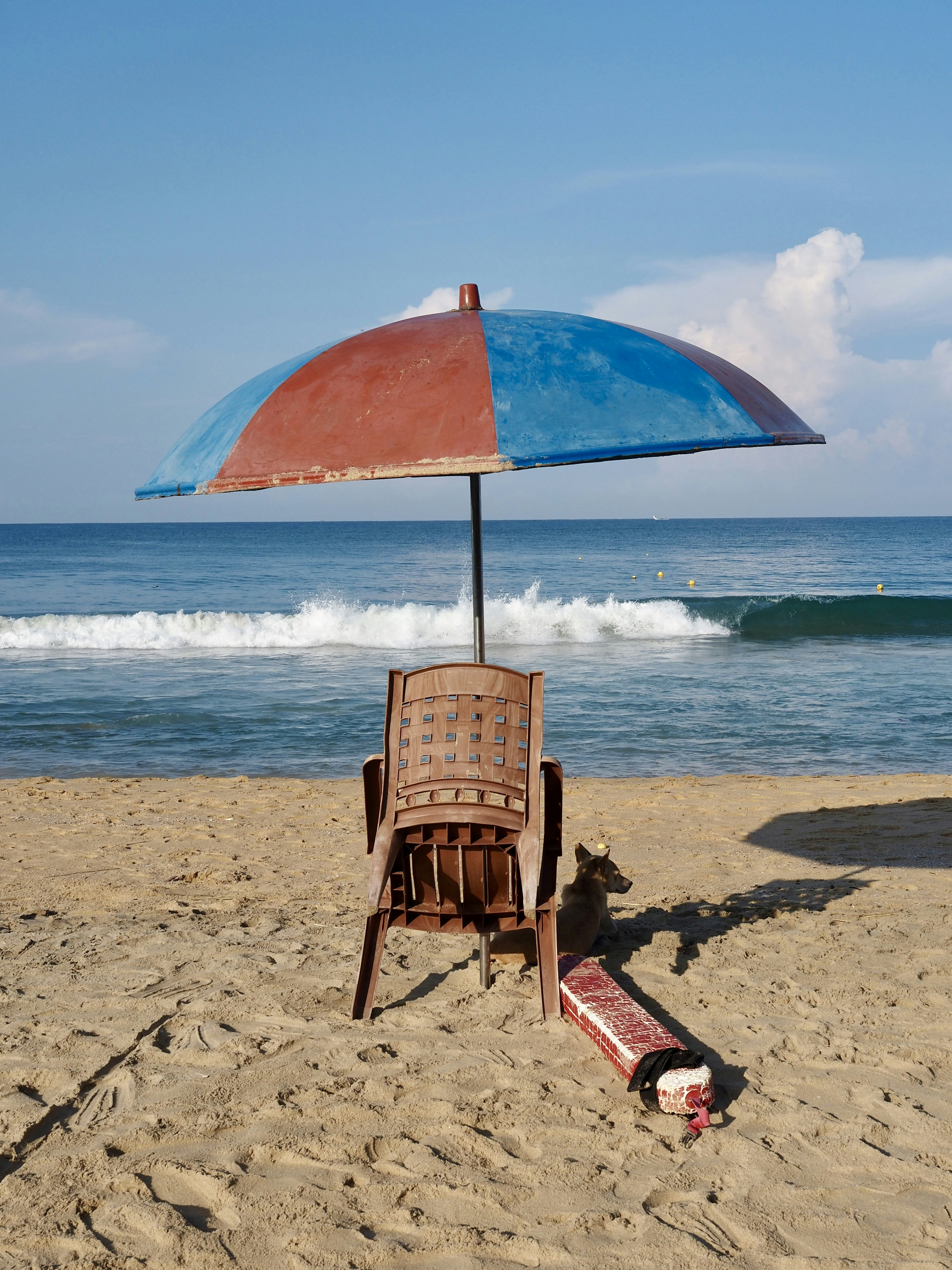 Color-blocked Umbrella Over Quiet Beach Chairs at Dusk-Tone Shore