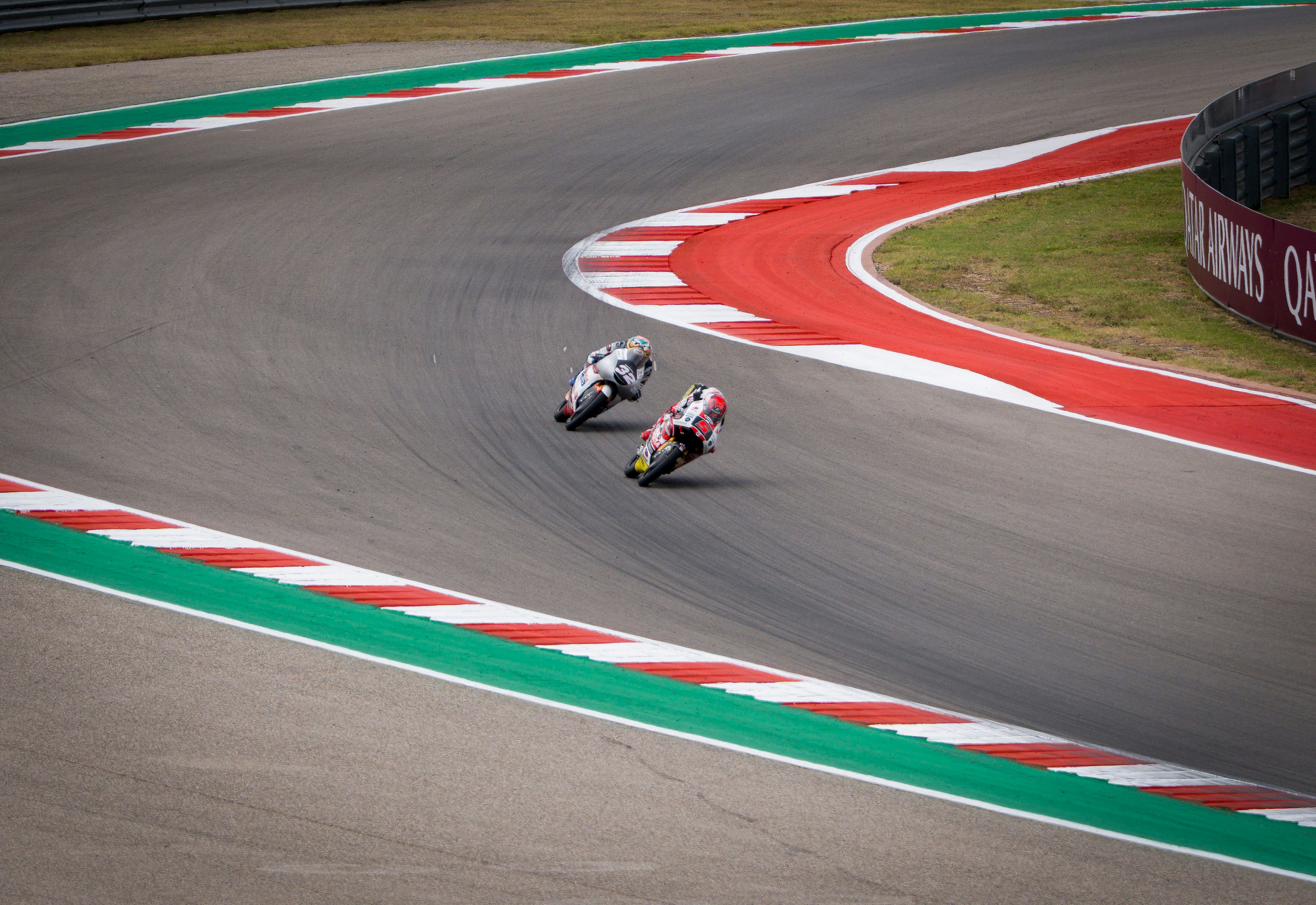 Racing Vortex: Dual Moto Sprint Through a Curved Red-White Tunnel