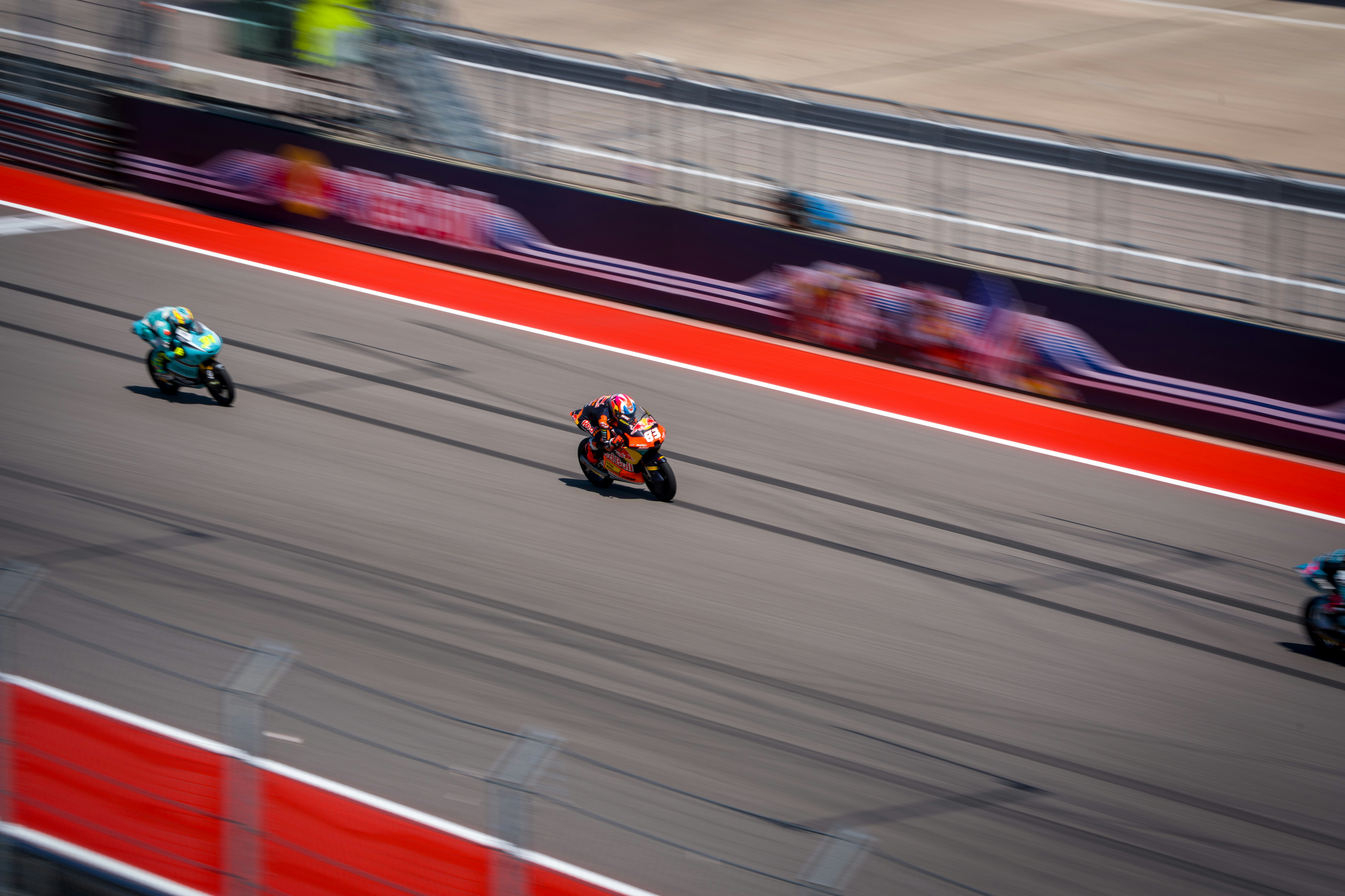 Blurring Sprint: A Pair of Moto Riders Cut Through the Curve