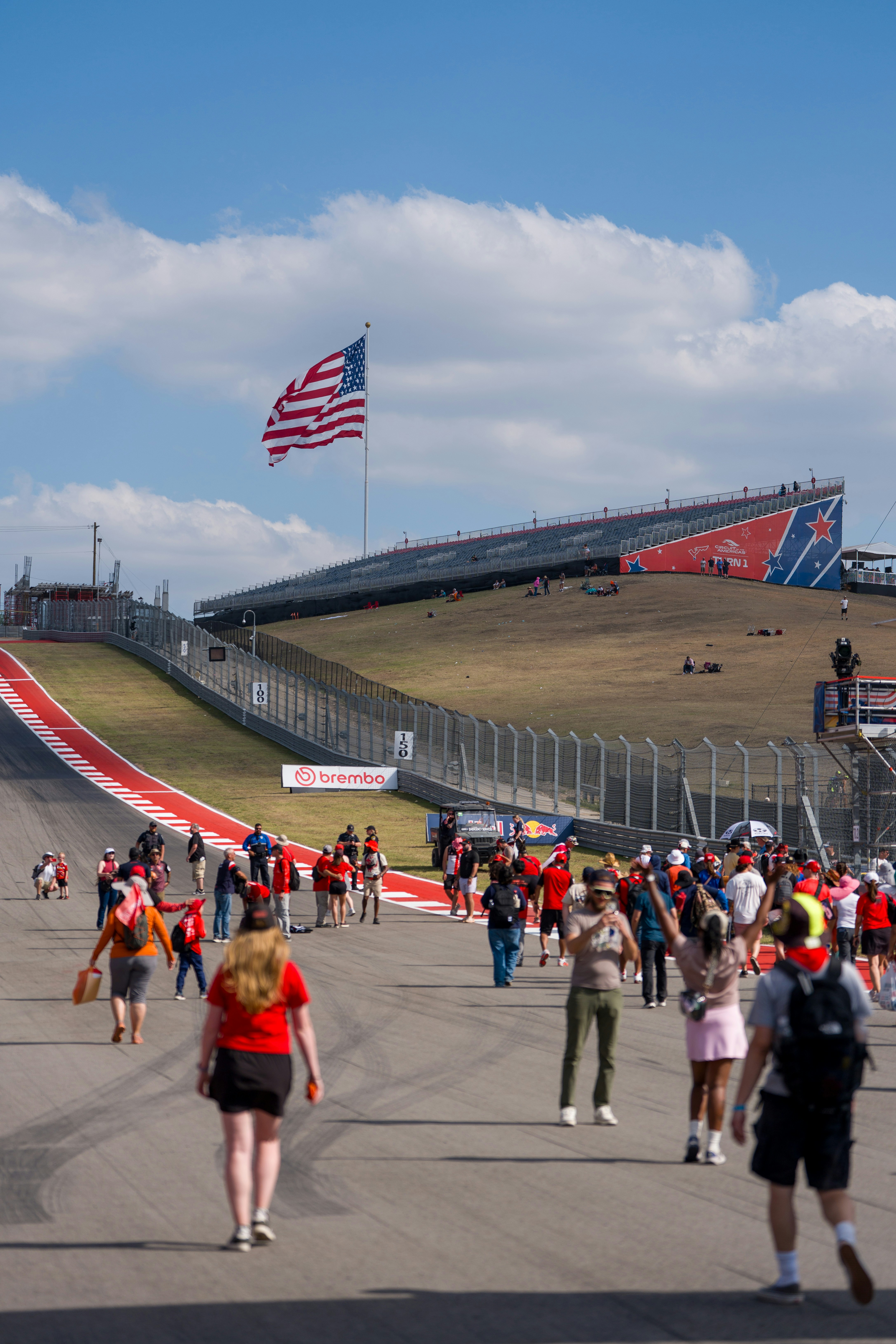 American Flag Above a Packed Pit Lane and Spectator Hill