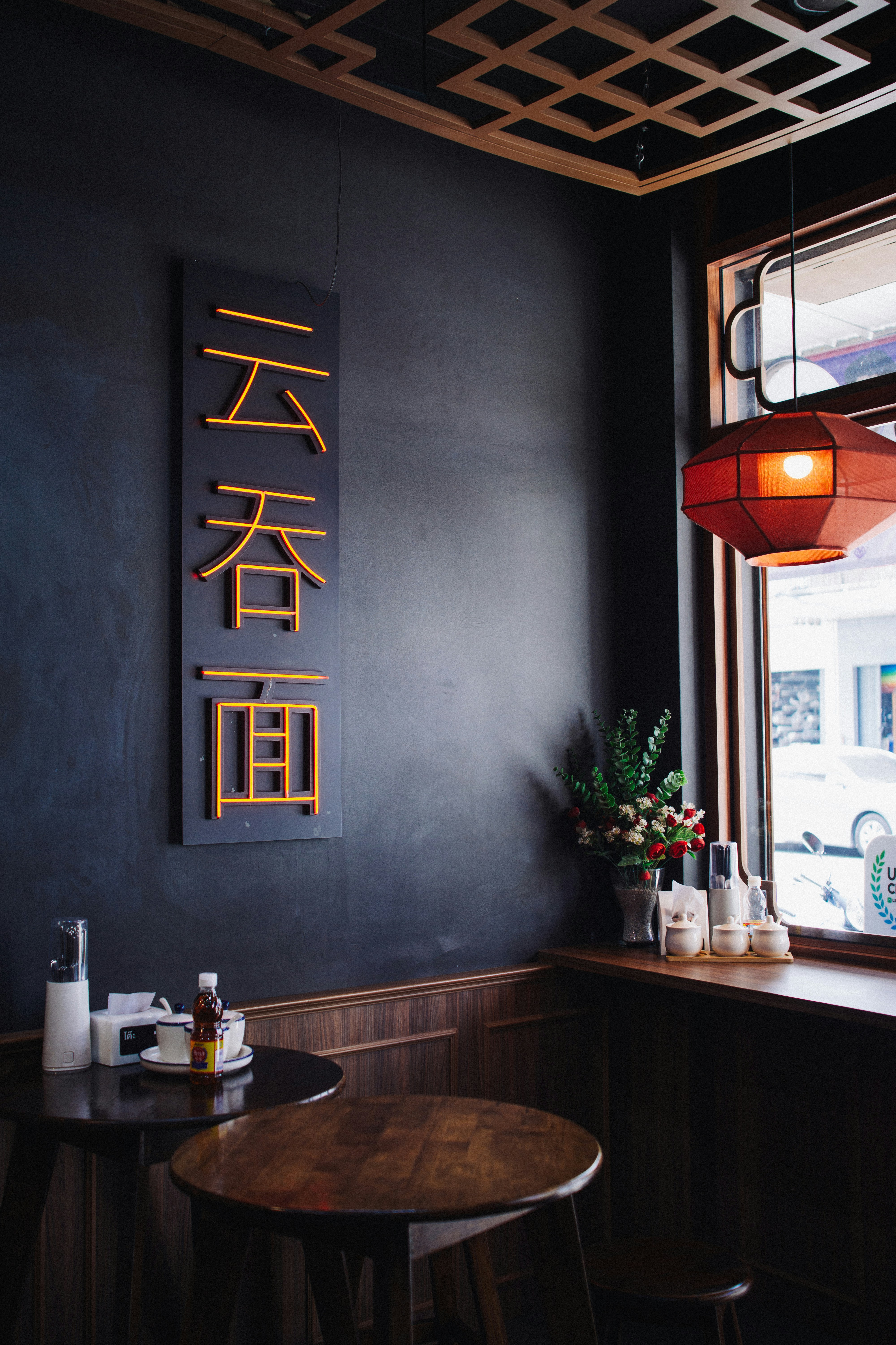 Neon Sign and Lantern Glow Inside a Quiet Asian Café
