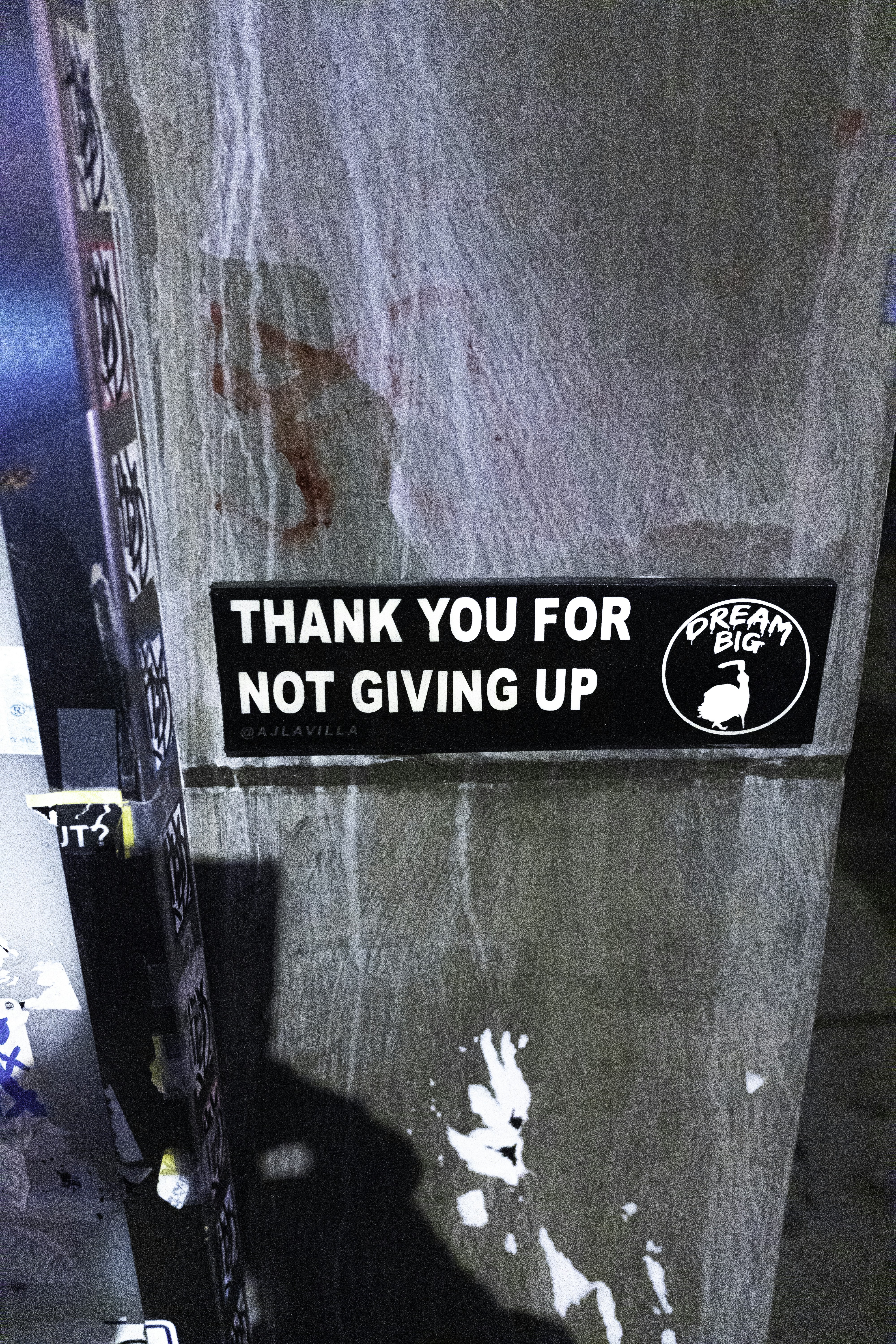 Stickered Concrete: A Street Corner's Quiet Message