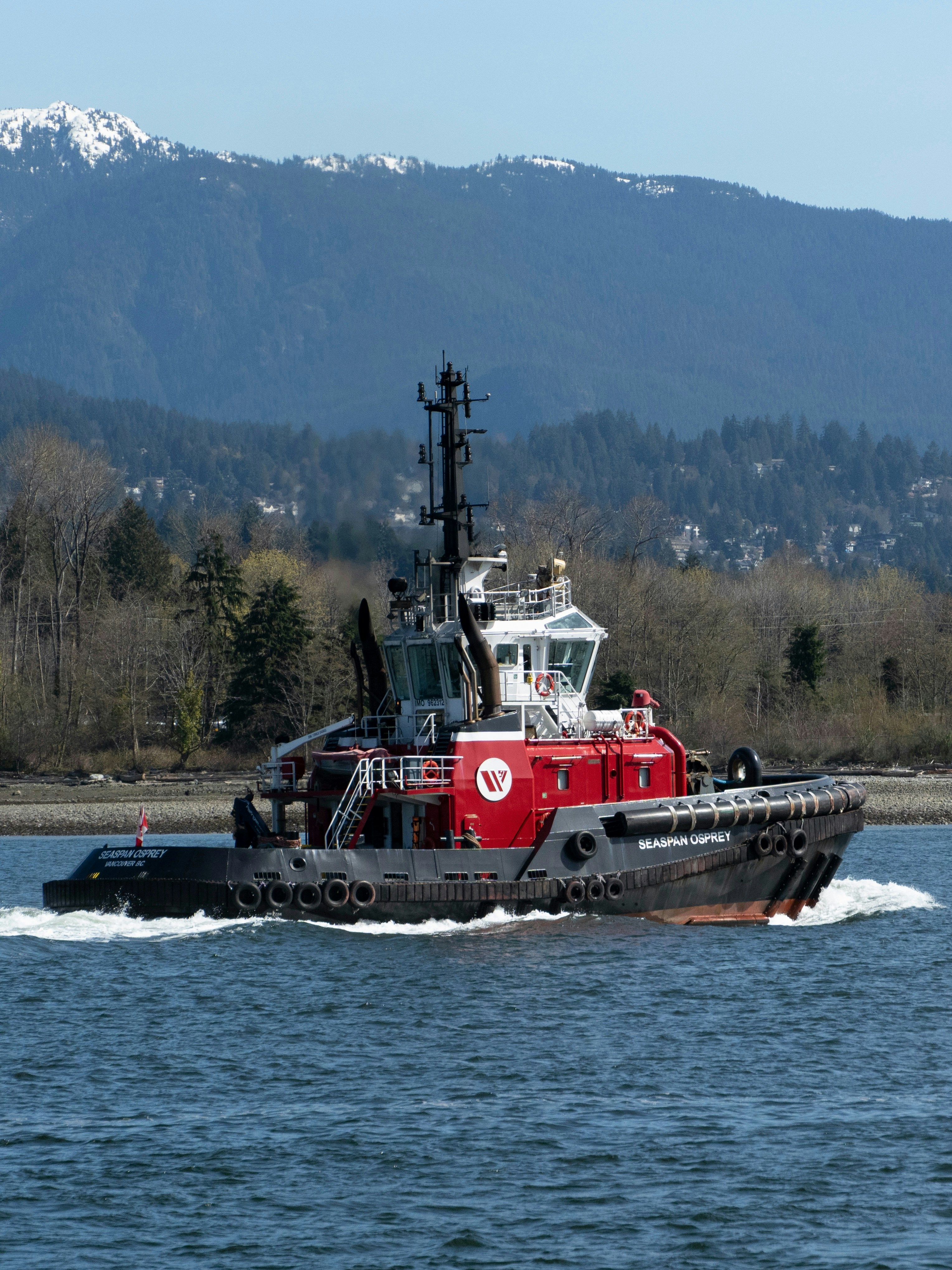 Towboat in Pacific Calm: Red Vessel Cutting Through Coastal Blues