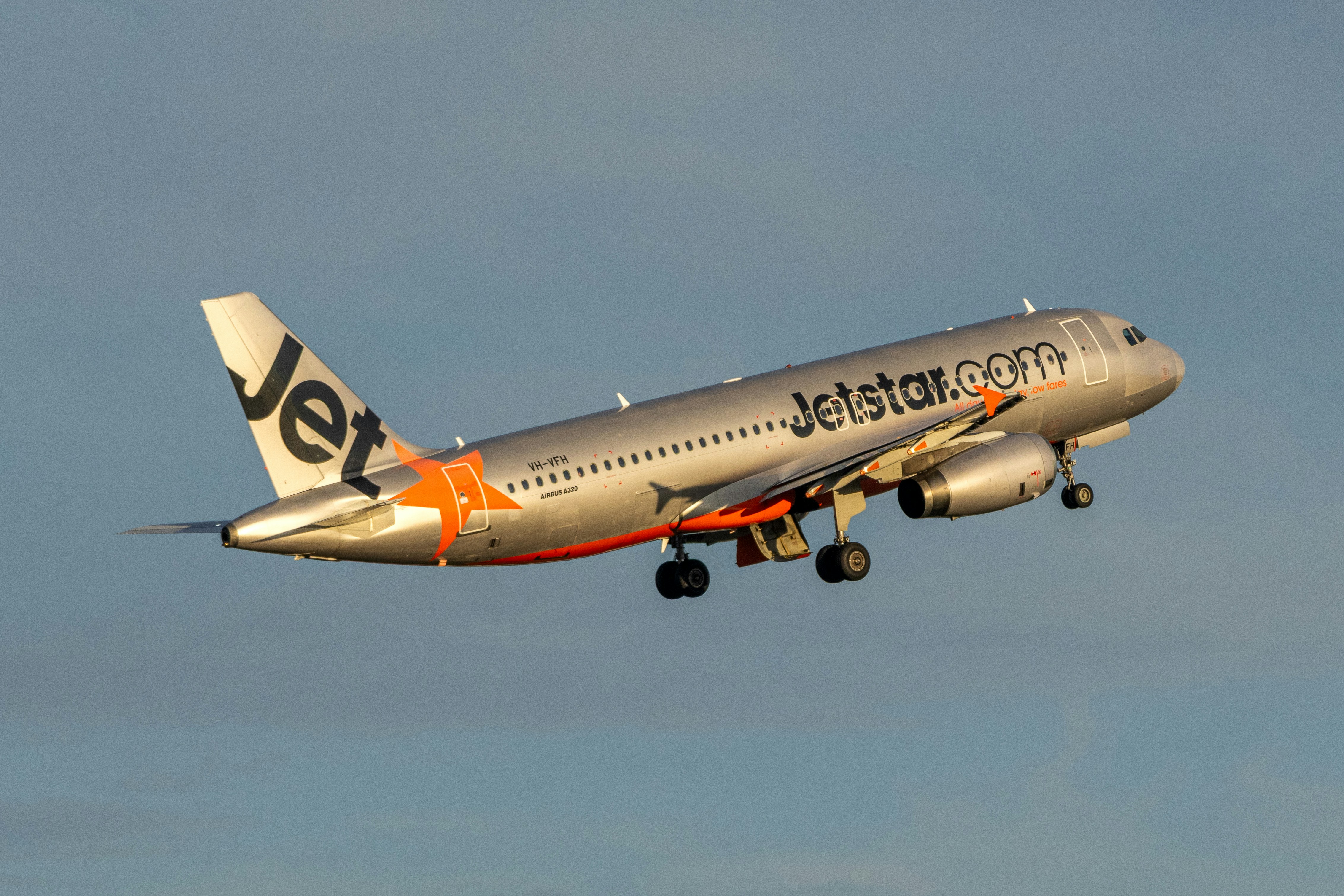 Jetstar in Lift-off: Silver Jet Against a Clear Sky