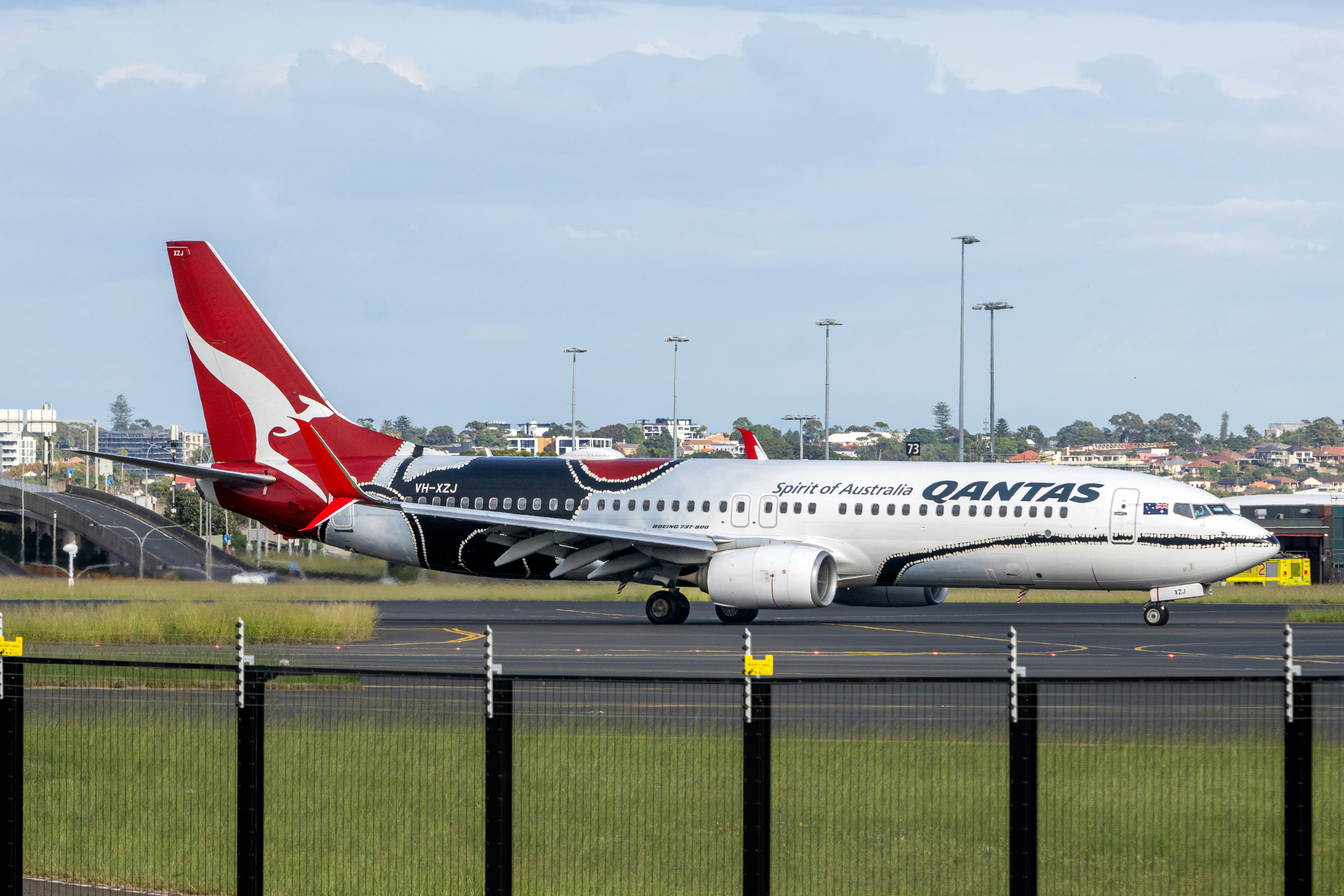 Qantas Jet on the Tarmac: Calm Aerials and Tailfin in Focus