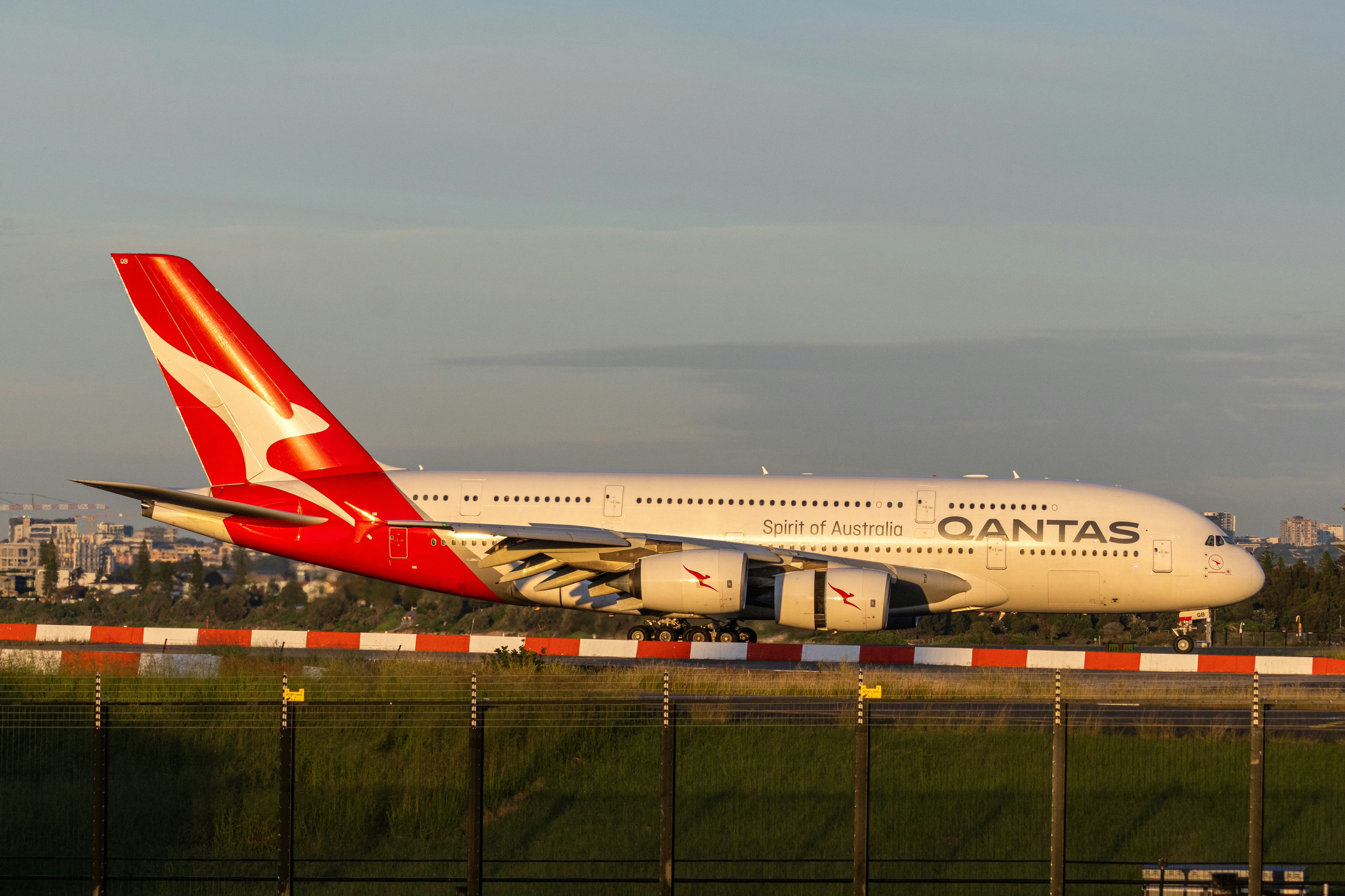 Quiet Giants: A Qantas A380 on the Tarmac at Sunset
